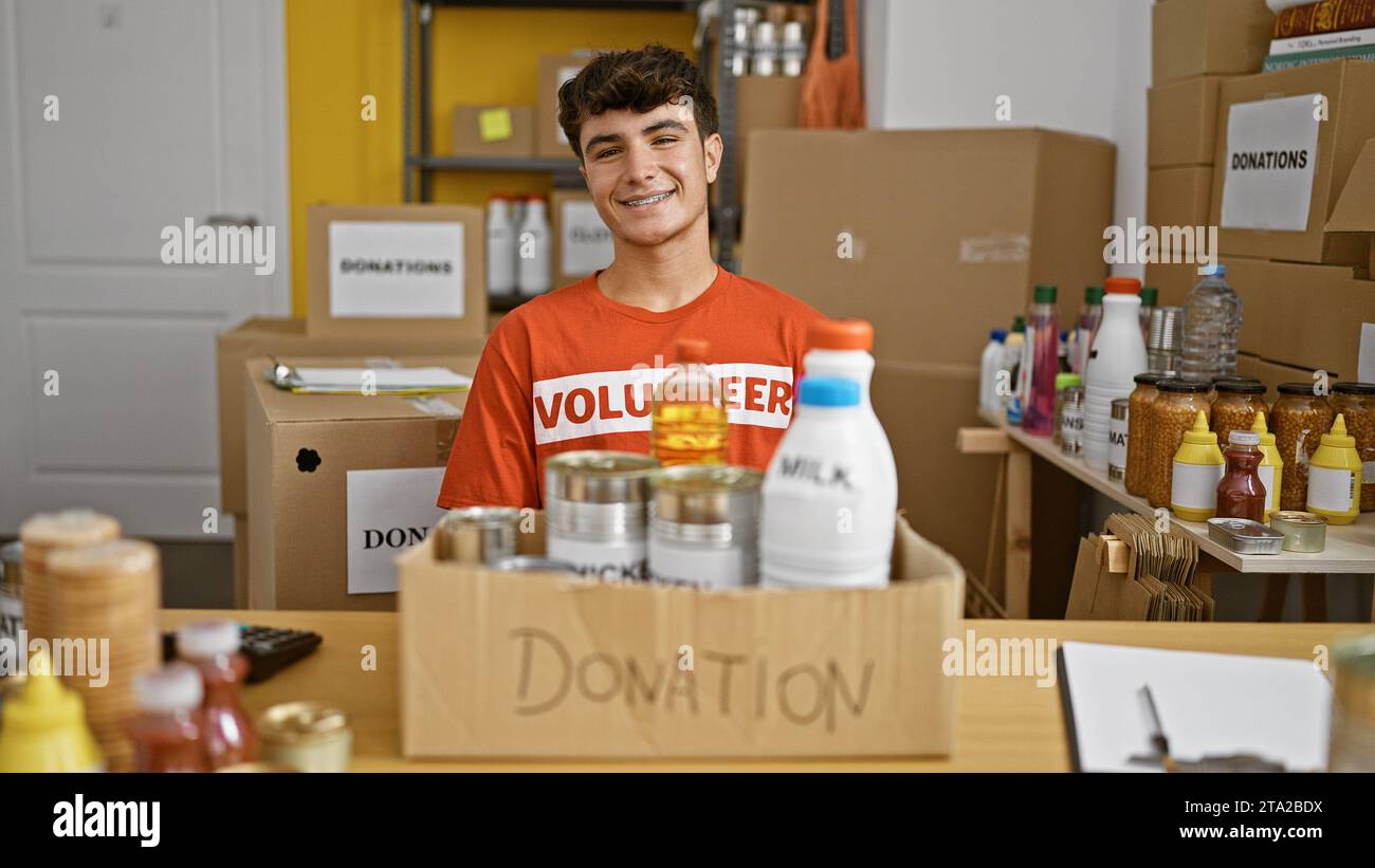 Confident young hispanic teenager boy enjoys volunteering, smiling ...