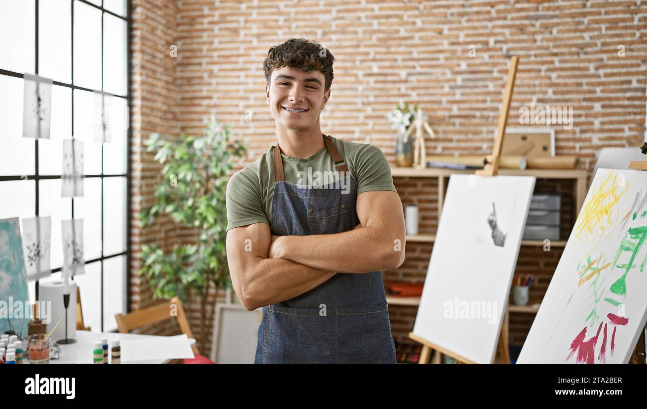 Confident young hispanic teenager, a budding art enthusiast, smiling ...