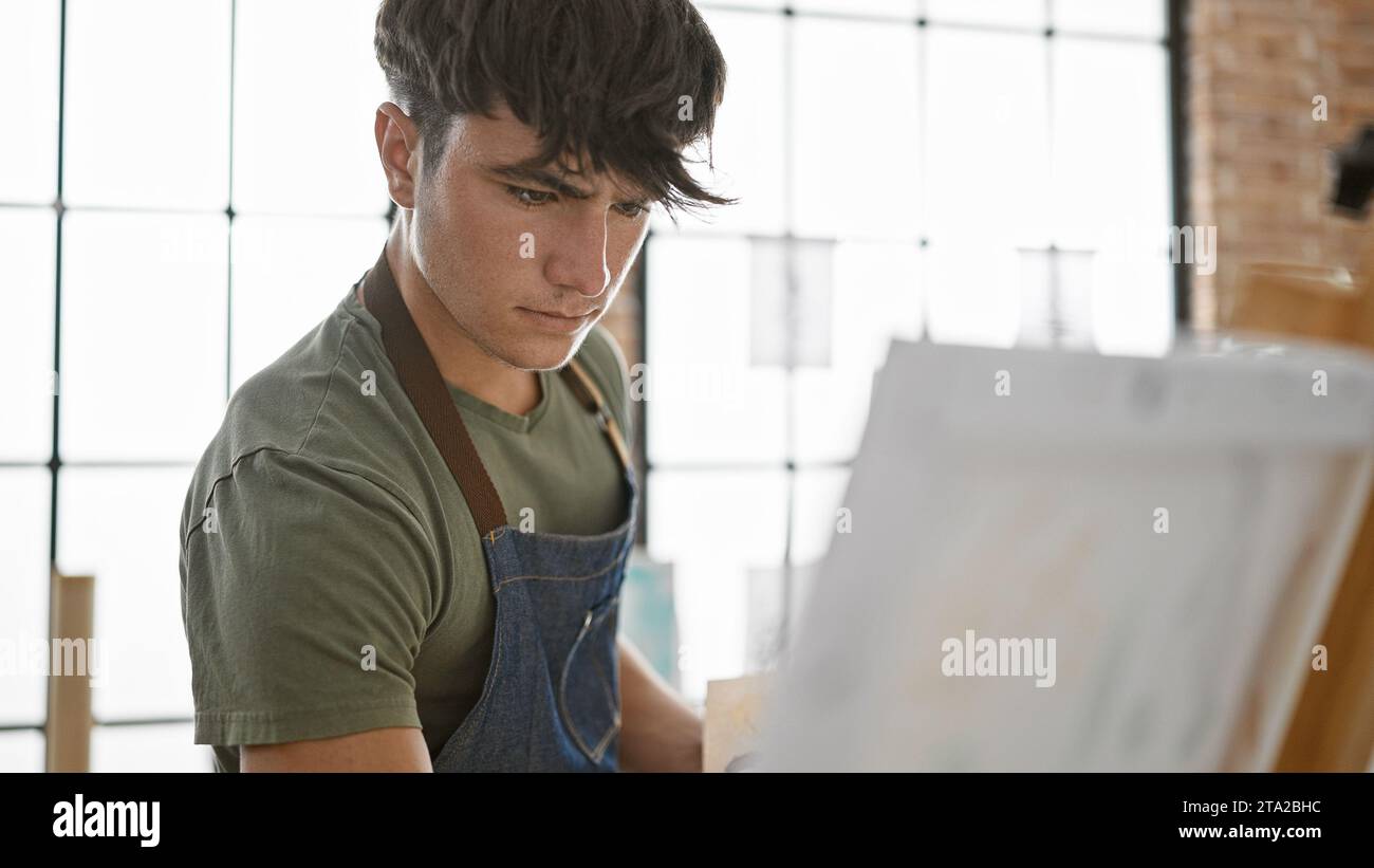 Serious young hispanic teenager artist engrossed in drawing portrait at ...