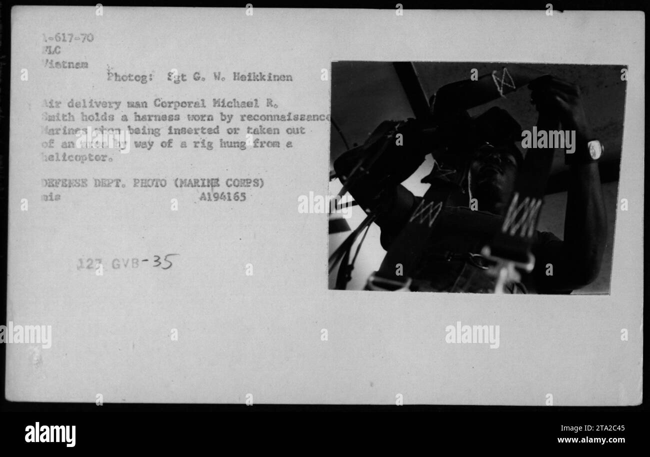 Air delivery man Corporal Michael R. Smith showcases a rig worn by ...