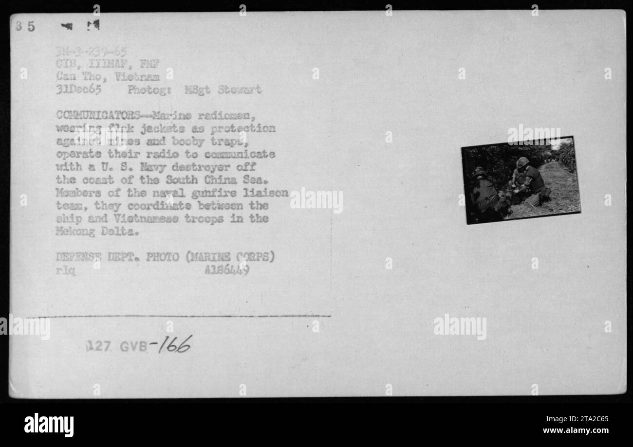 Marine radiomen, equipped with flak jackets, operate radios to ...