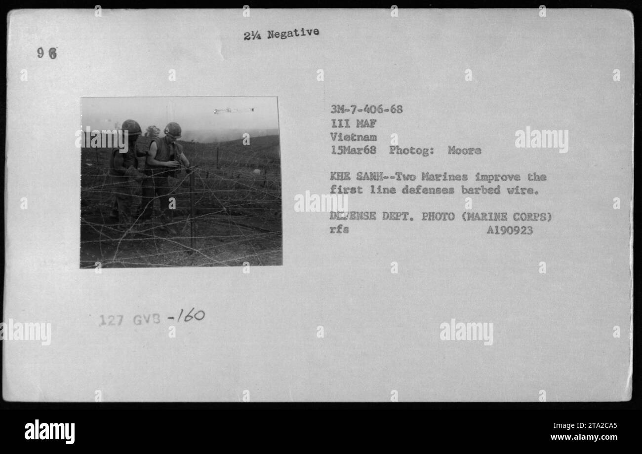 Two Marines improve barbed wire defenses at Khe Sanh combat base ...