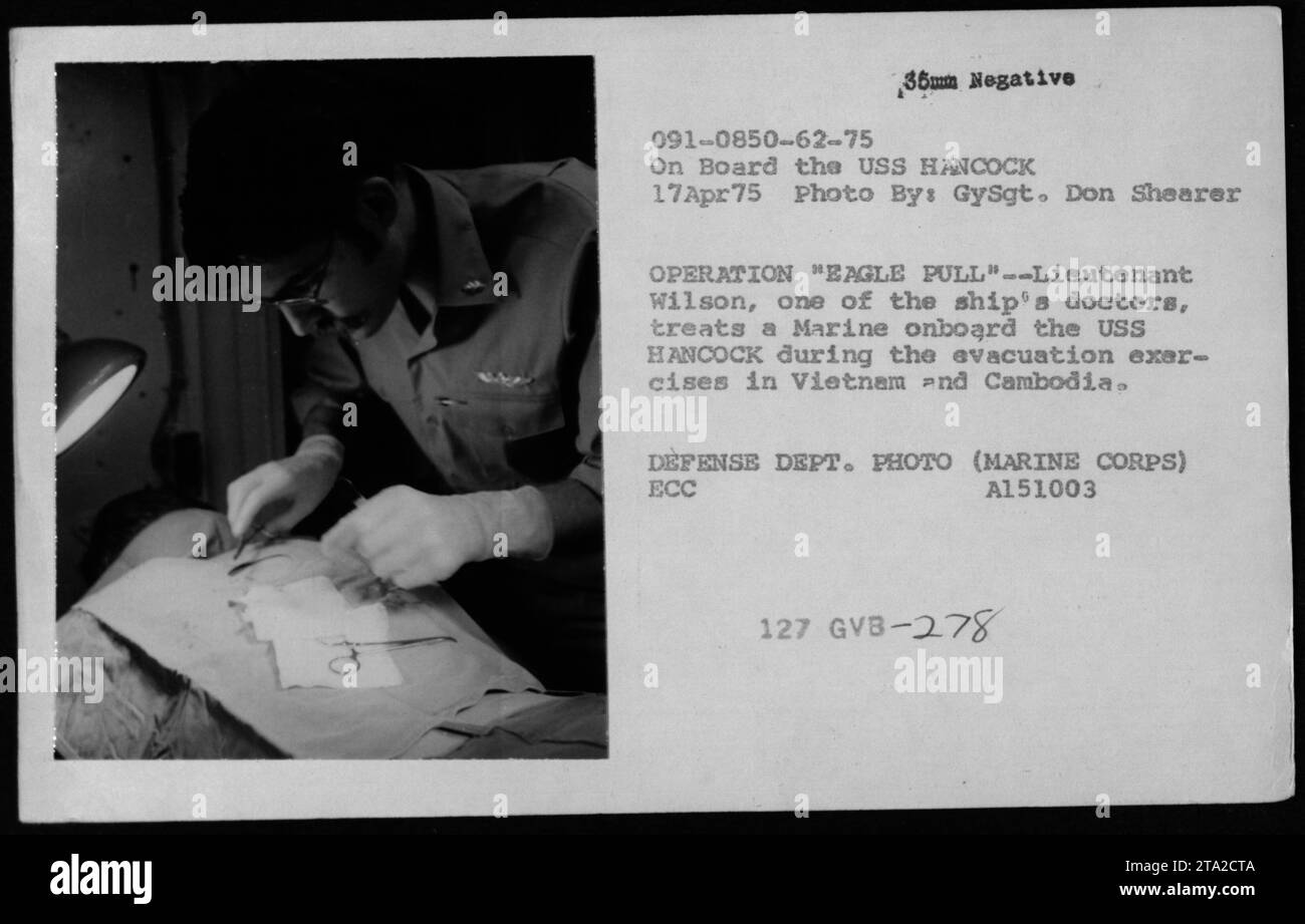 Lieutenant Wilson, a ship's doctor, treats a Marine onboard the USS ...