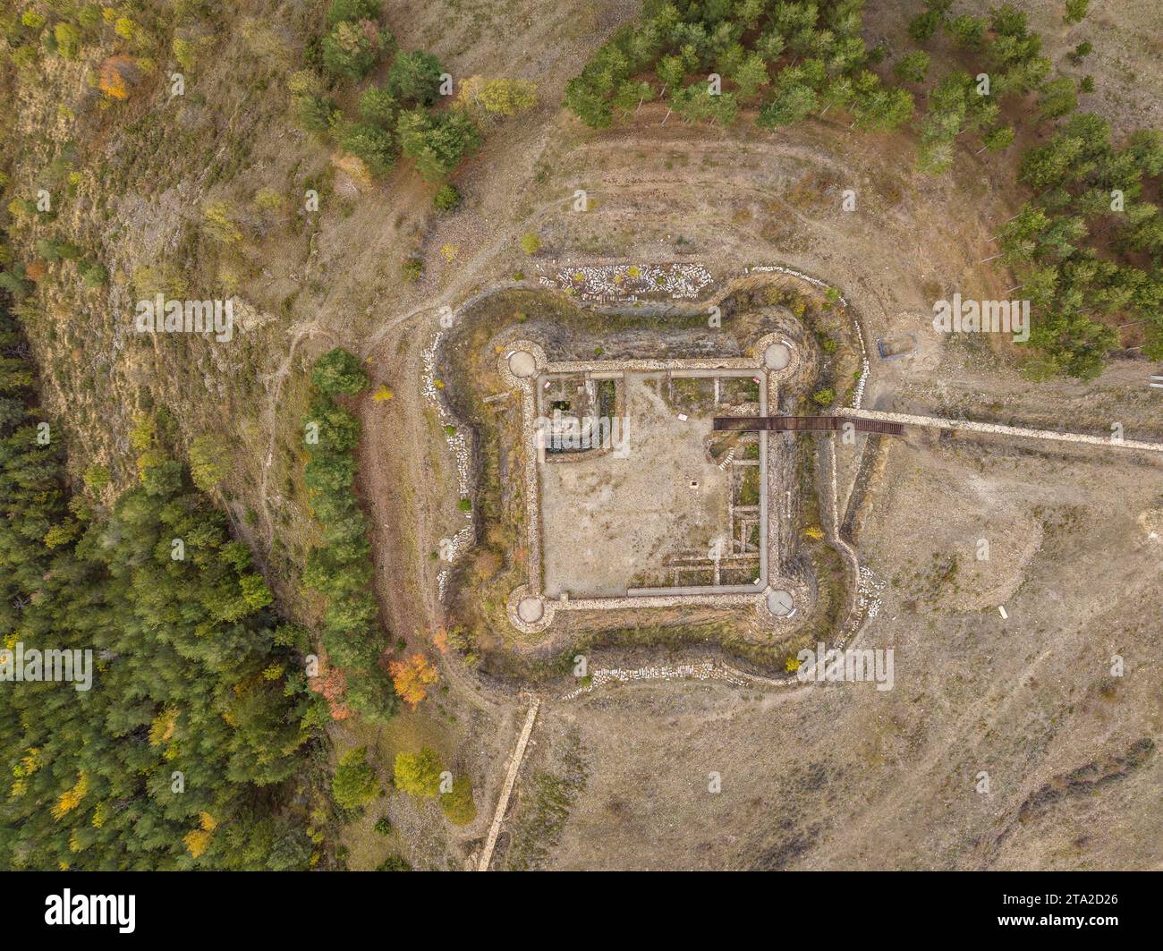 Aerial overhead view of the Llívia castle between fog and clouds ...