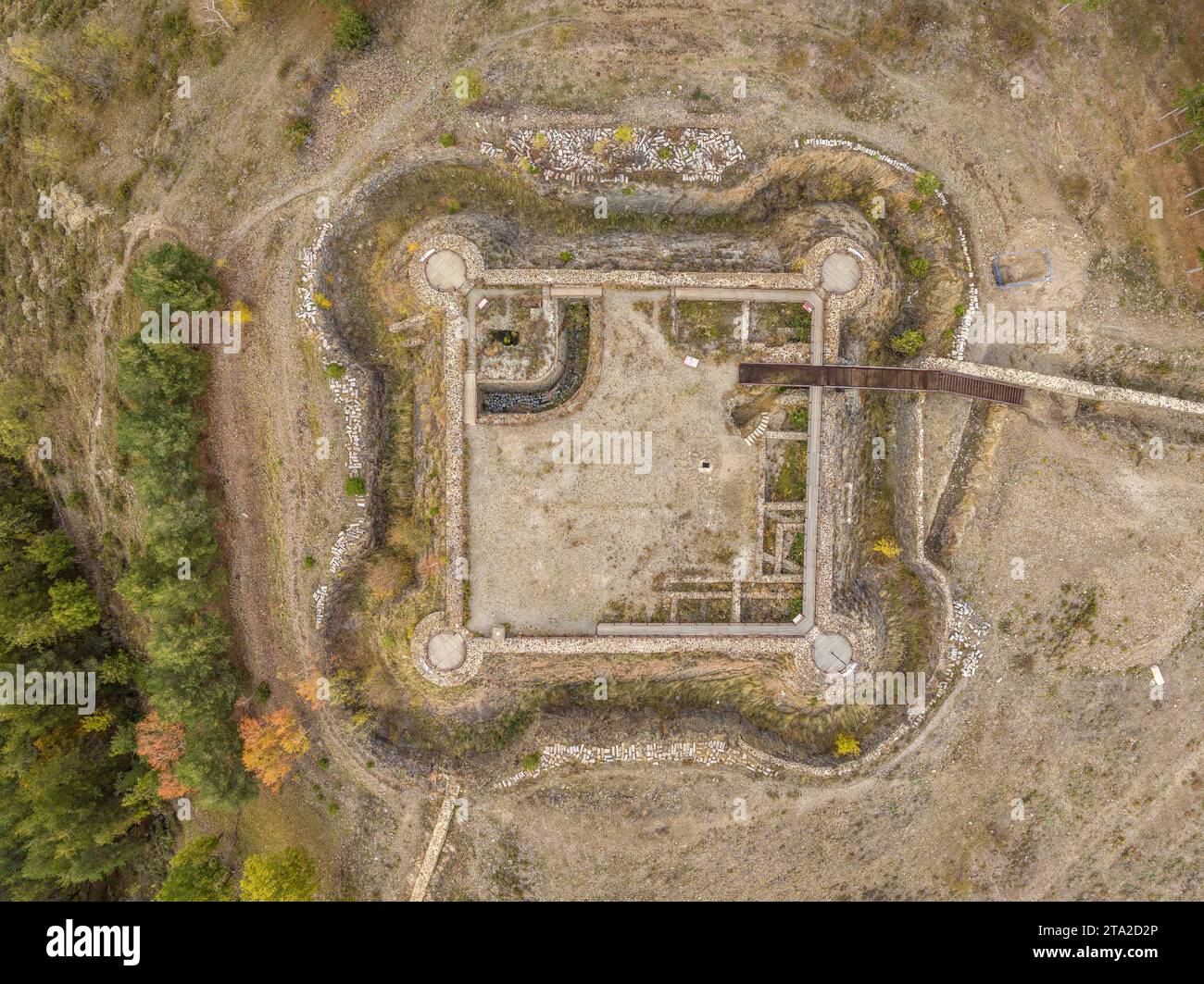 Aerial overhead view of the Llívia castle between fog and clouds ...
