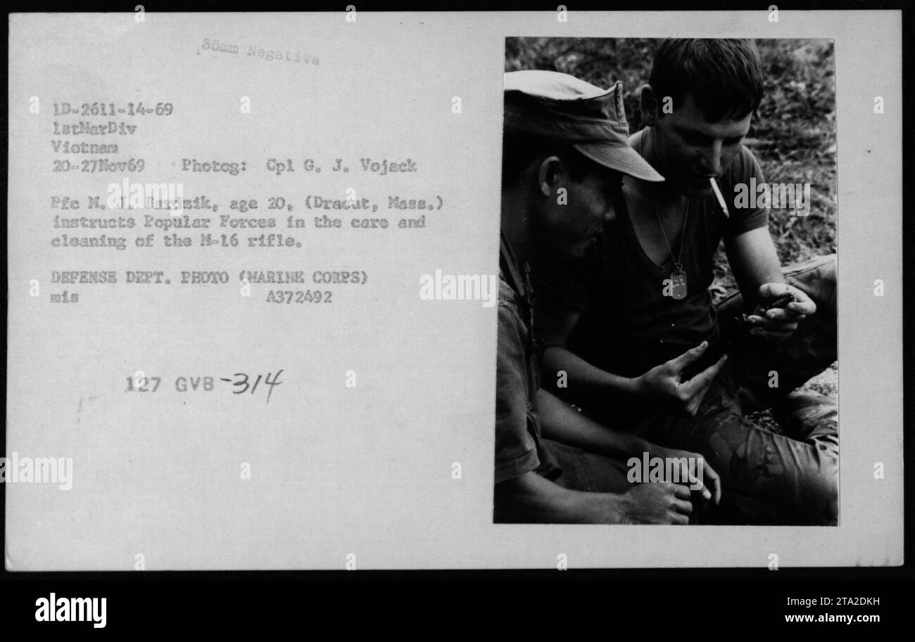 ARVN soldier, Pfc M. J. Bardzik, is seen instructing Popular Forces in ...