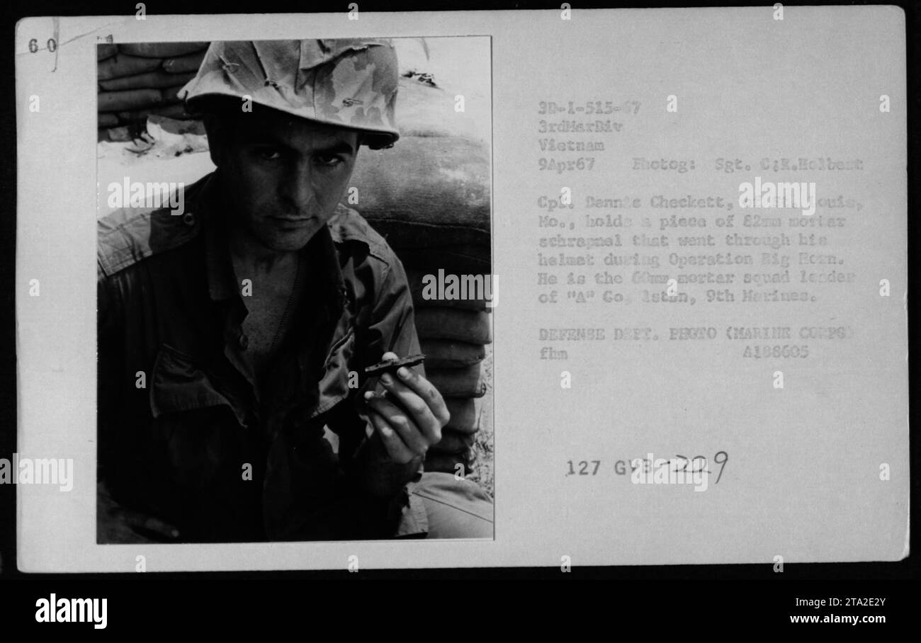 Cpl. Denne Checkett, from St. Louis, Missouri, holds a piece of 82mm ...