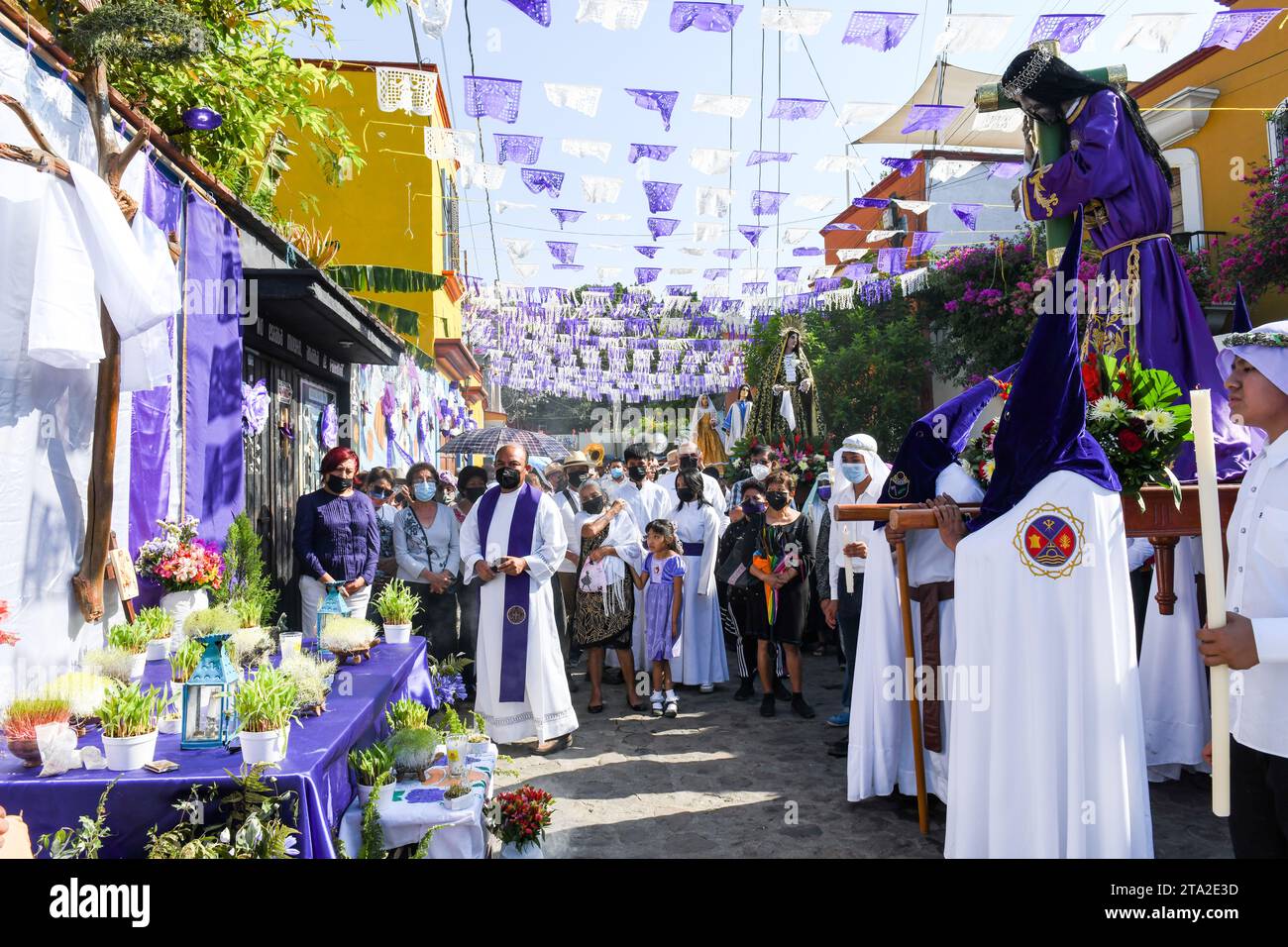 Priest and Believers pray in front of home altars during the Good ...