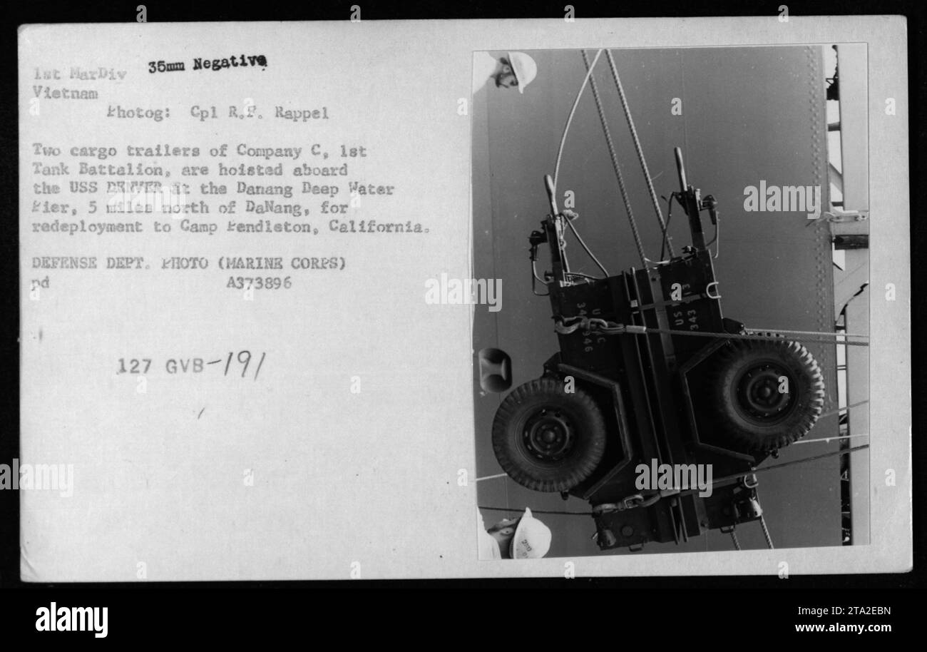 Members of Company C, 1st Tank Battalion, load cargo trailers onto the ...