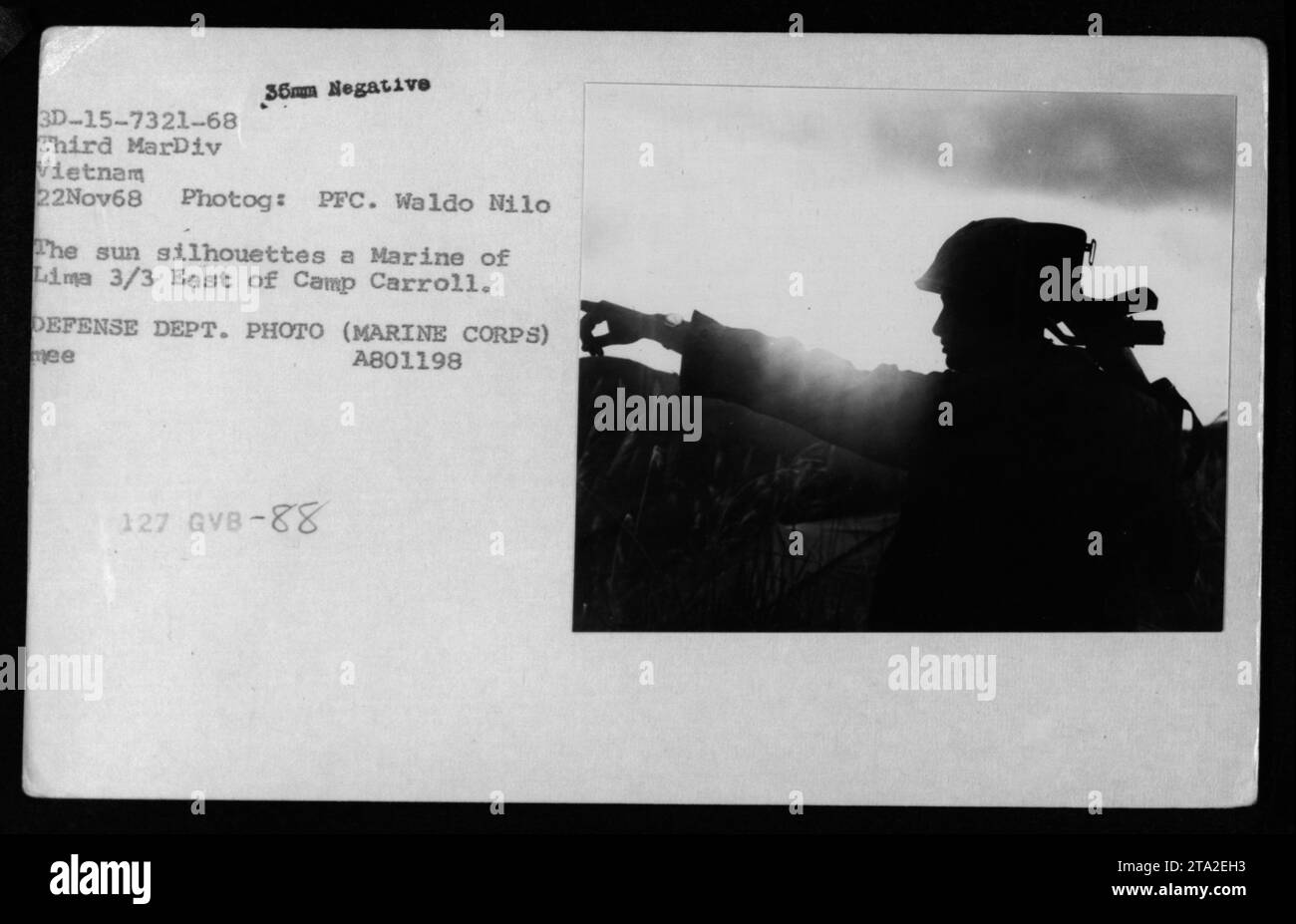 A Marine of Lima 3/3 is silhouetted against the setting sun while ...