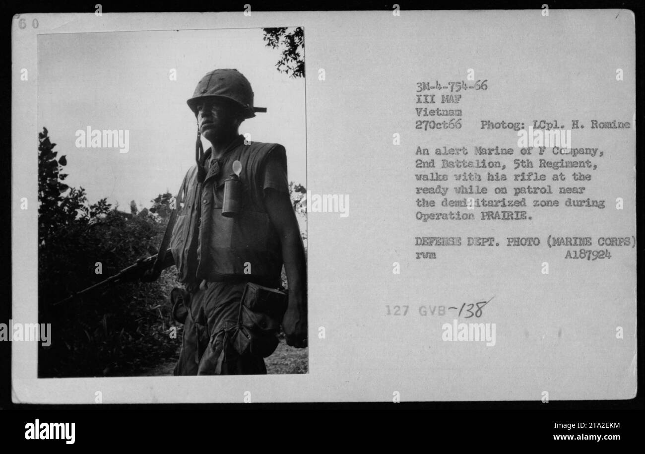 A Marine from F Company, 2nd Battalion, 5th Regiment, keeps his rifle ...