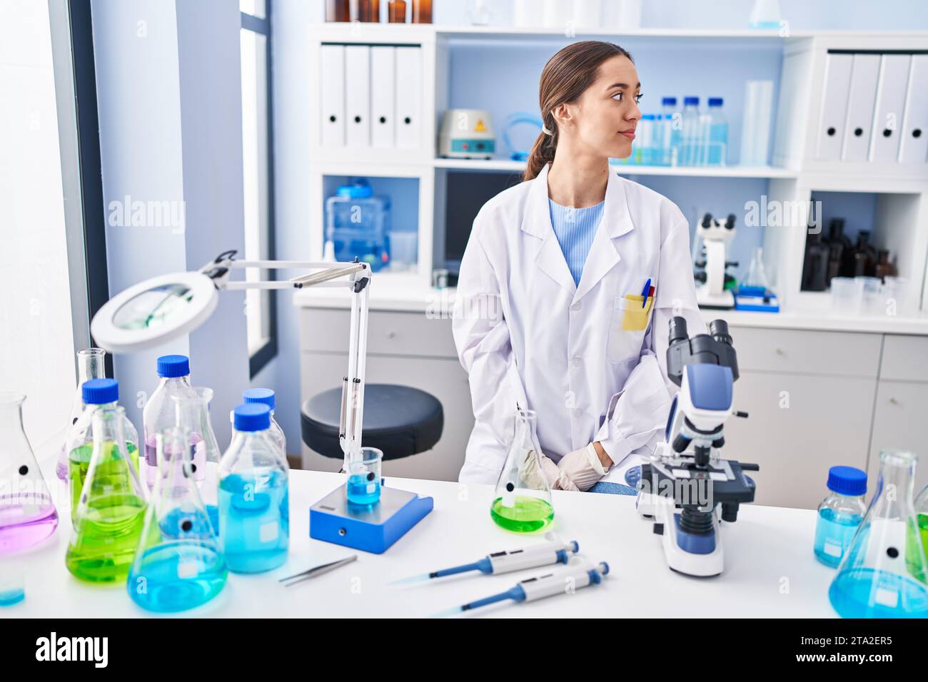 Looking into microscope silhouette hi-res stock photography and images ...