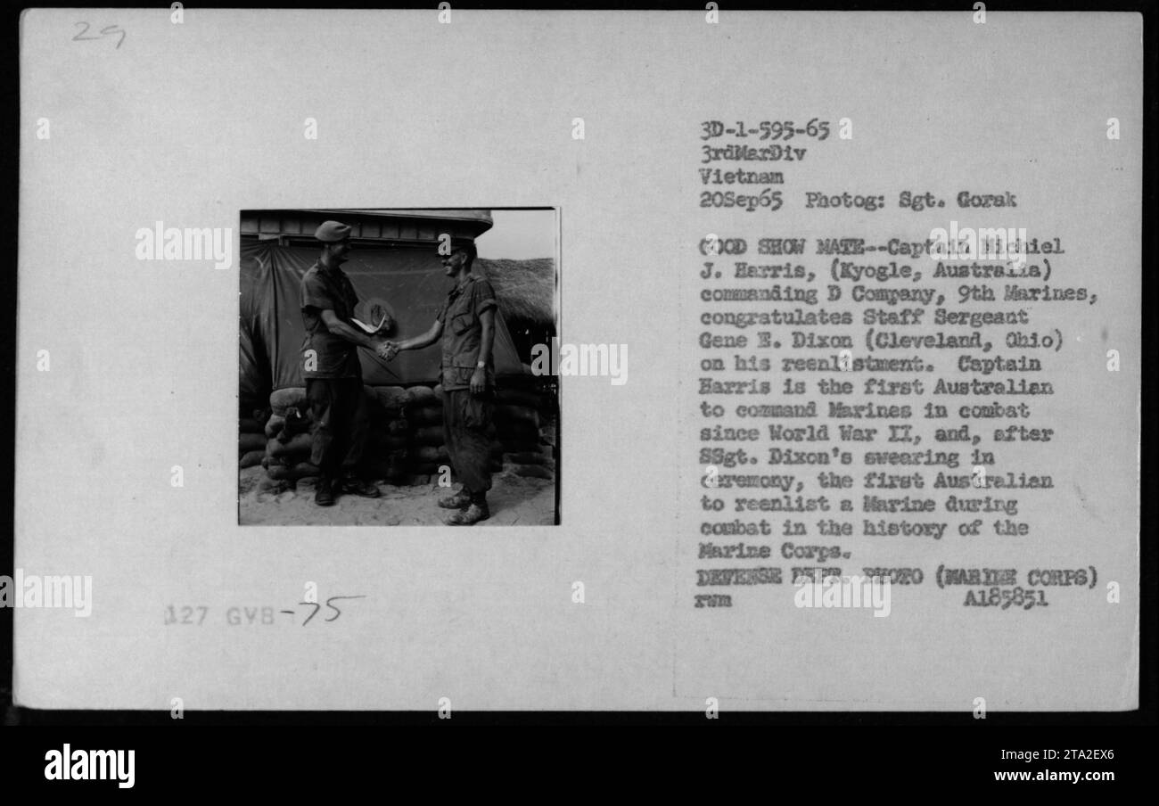 Captain Michiel J. Harris of D Company, 9th Marines, congratulates ...