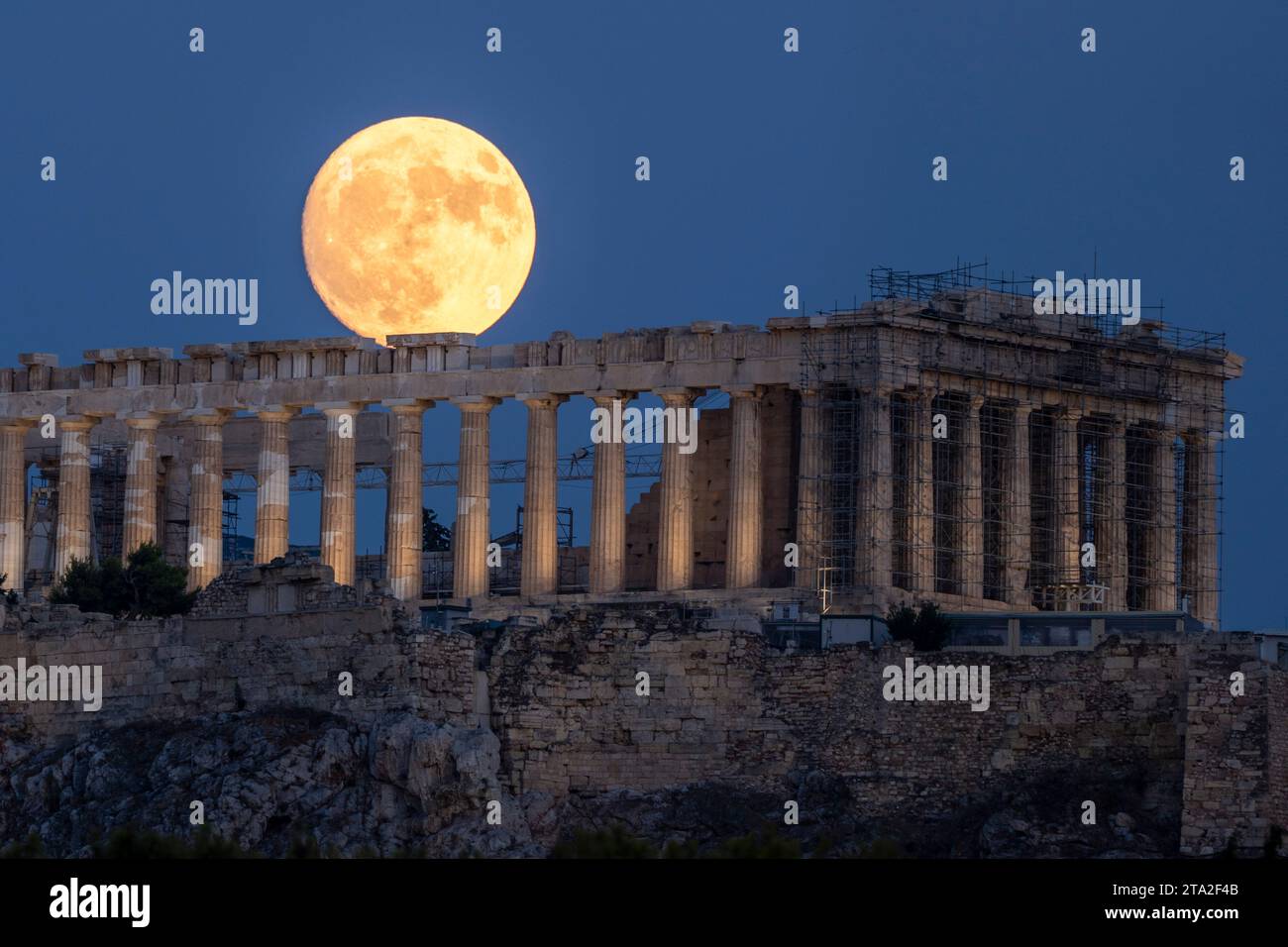 FILE - The moon rises in the sky behind the 5th century B.C. Parthenon ...