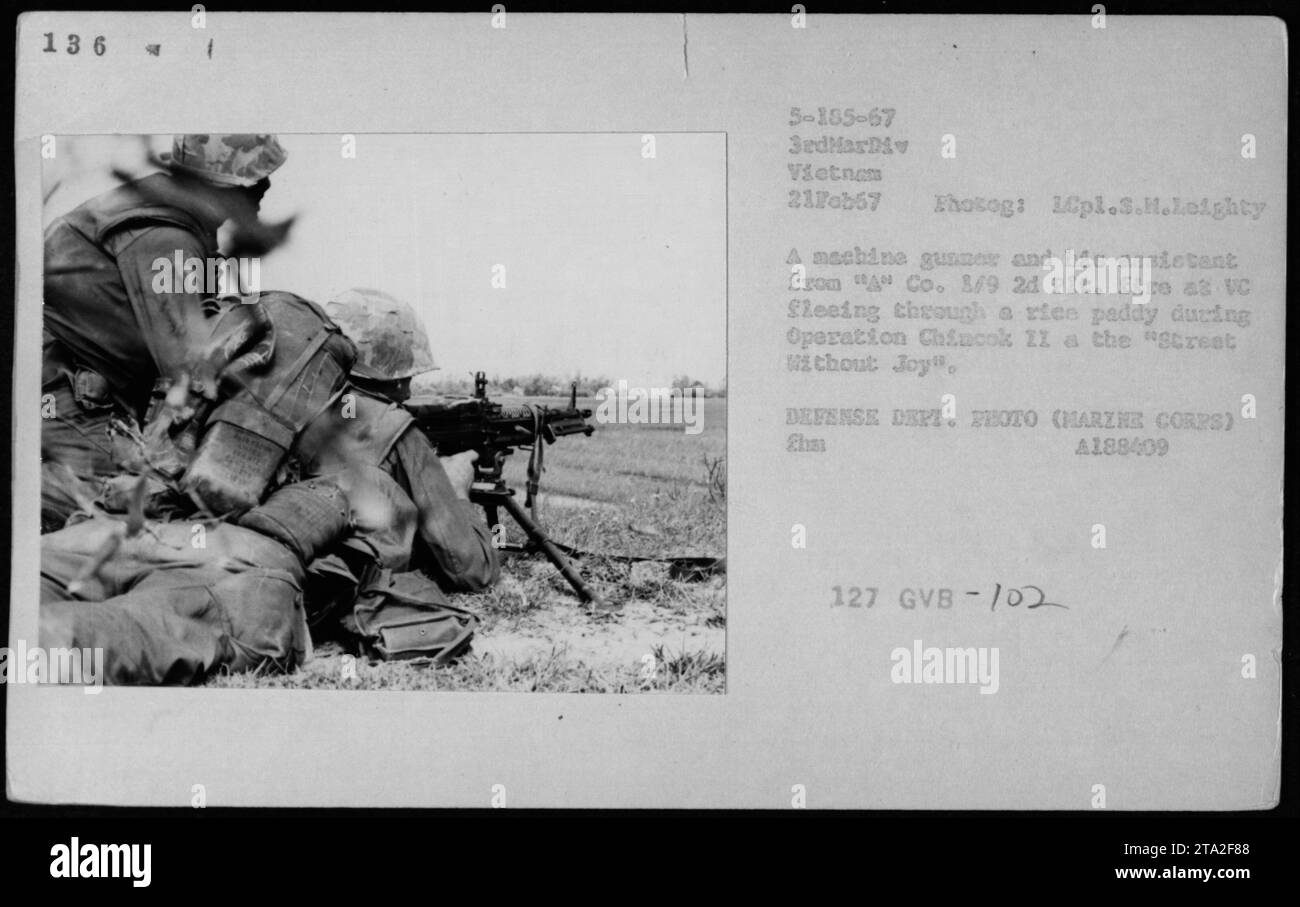 A machine gunner and assistant from A Company, 3rd Marine Division ...