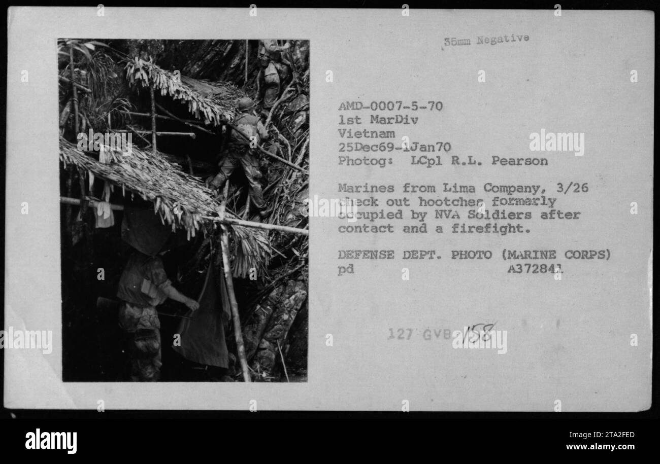 Marines from Lima Company, 3/26 examine abandoned NVA huts after a ...