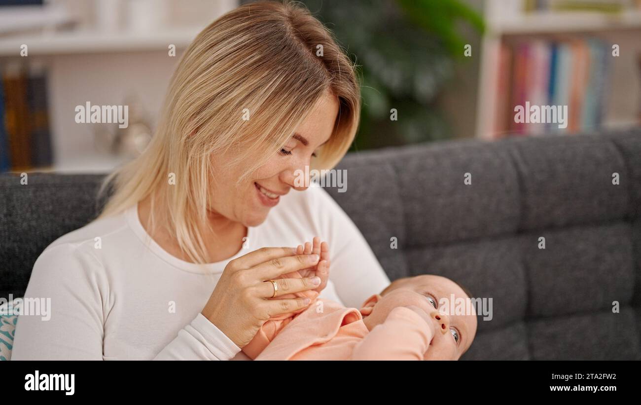 Mother and daughter hugging each other at home Stock Photo - Alamy