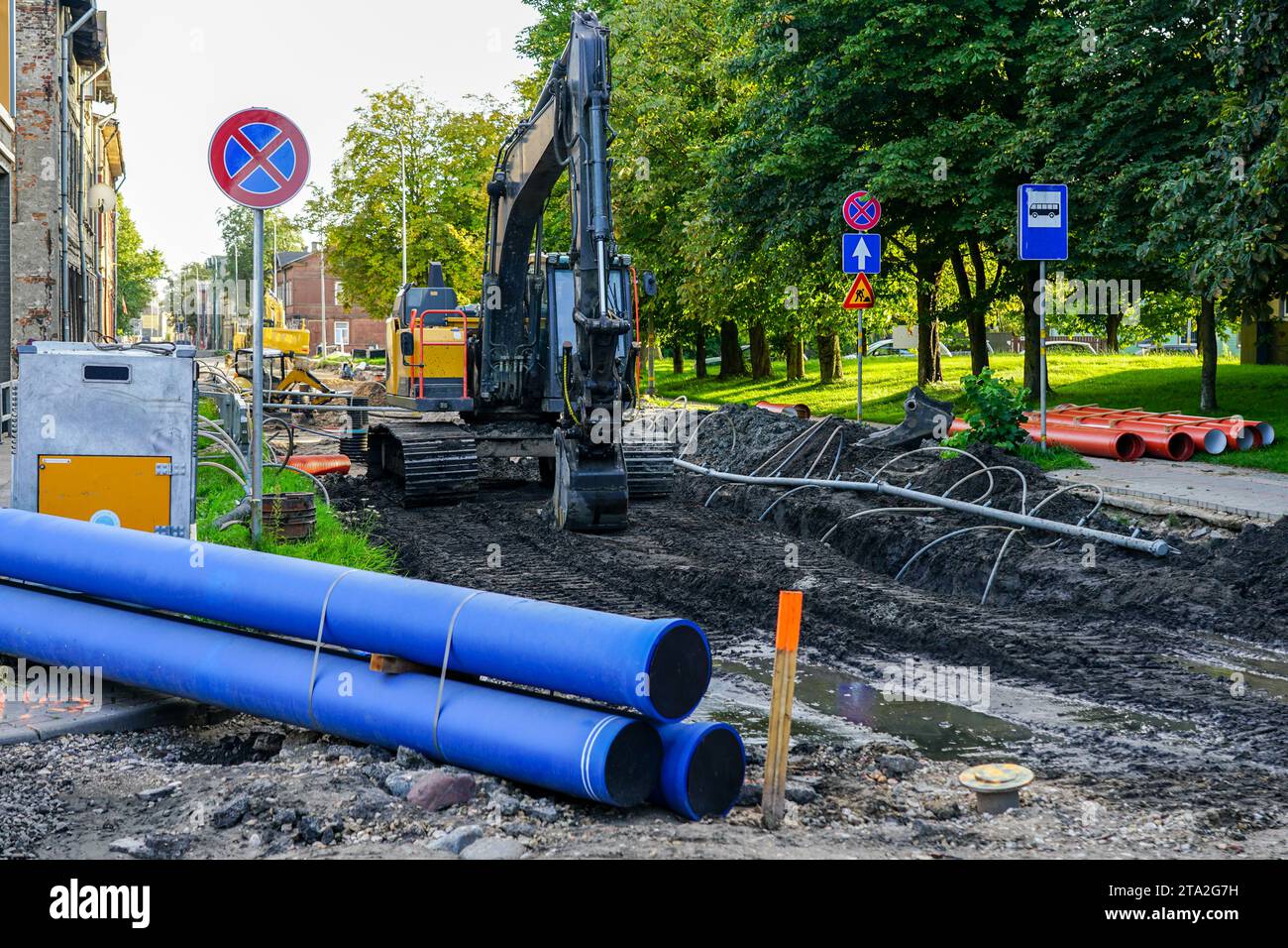 New blue thick plastic underground water supply pipes near trench on ...