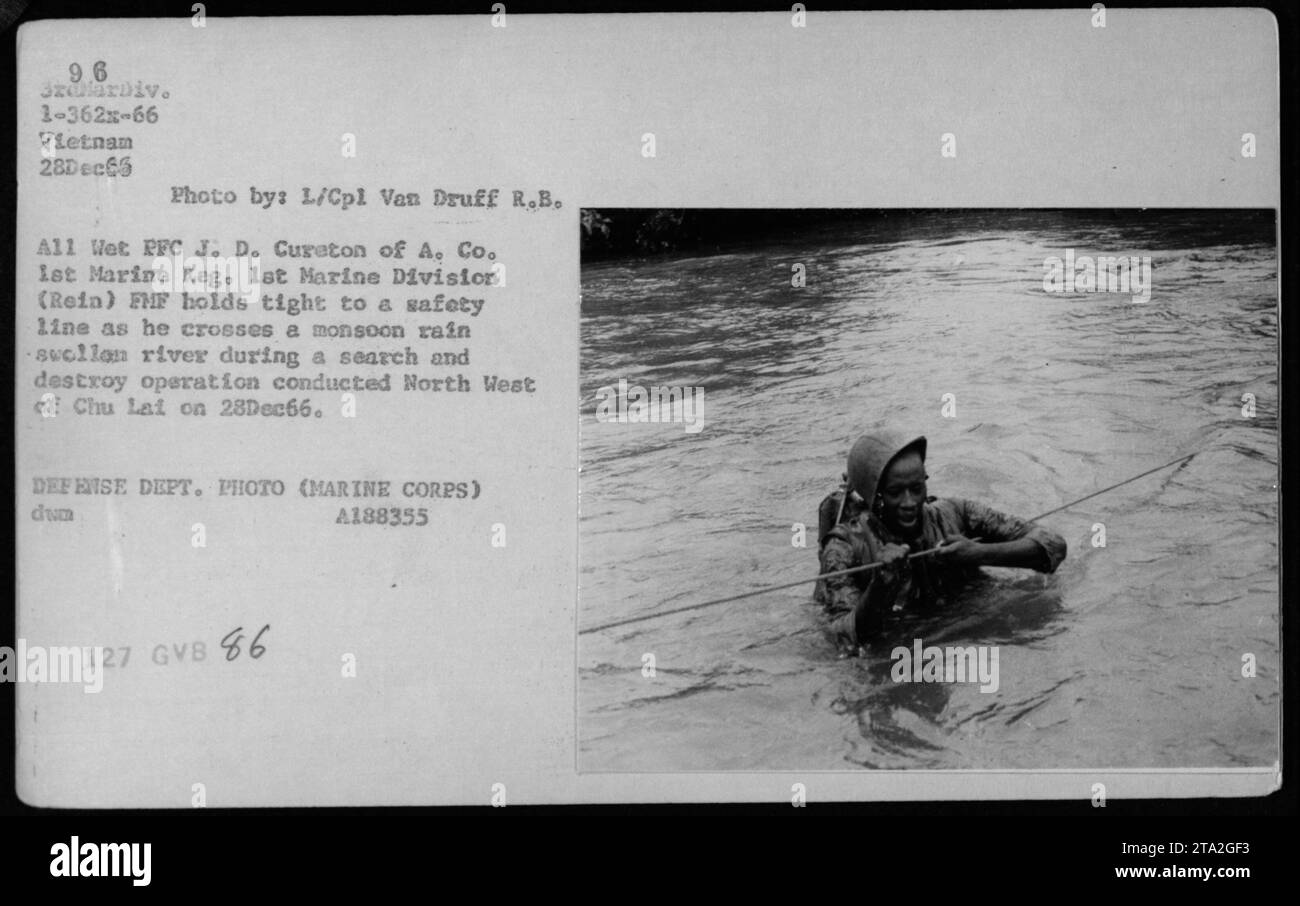 PFC J.D. Cureton of A Company, 1st Marine Regiment, crosses a monsoon ...