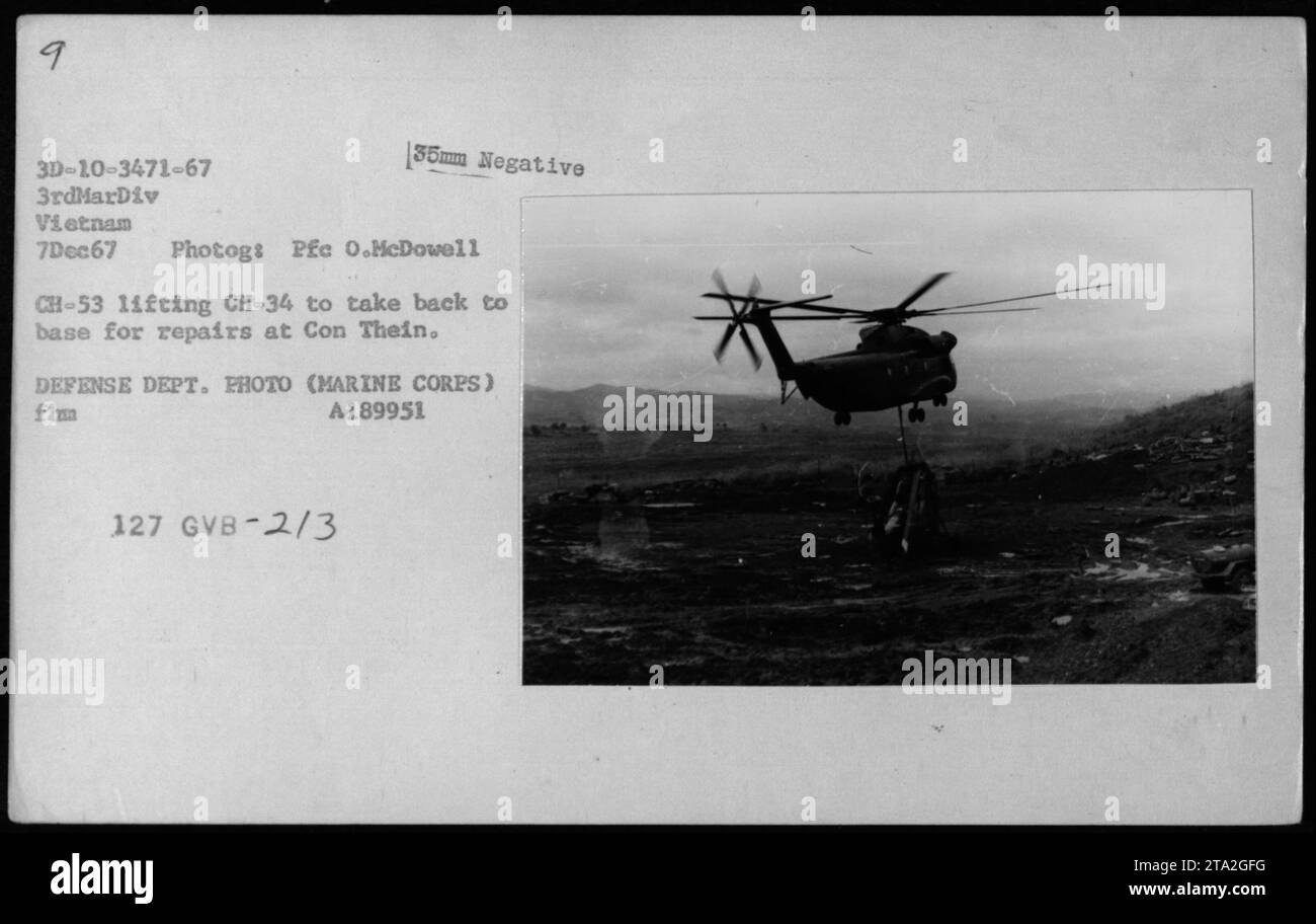 "A U.S. Marine CH-53 helicopter is seen lifting a CH-34 for repairs at ...