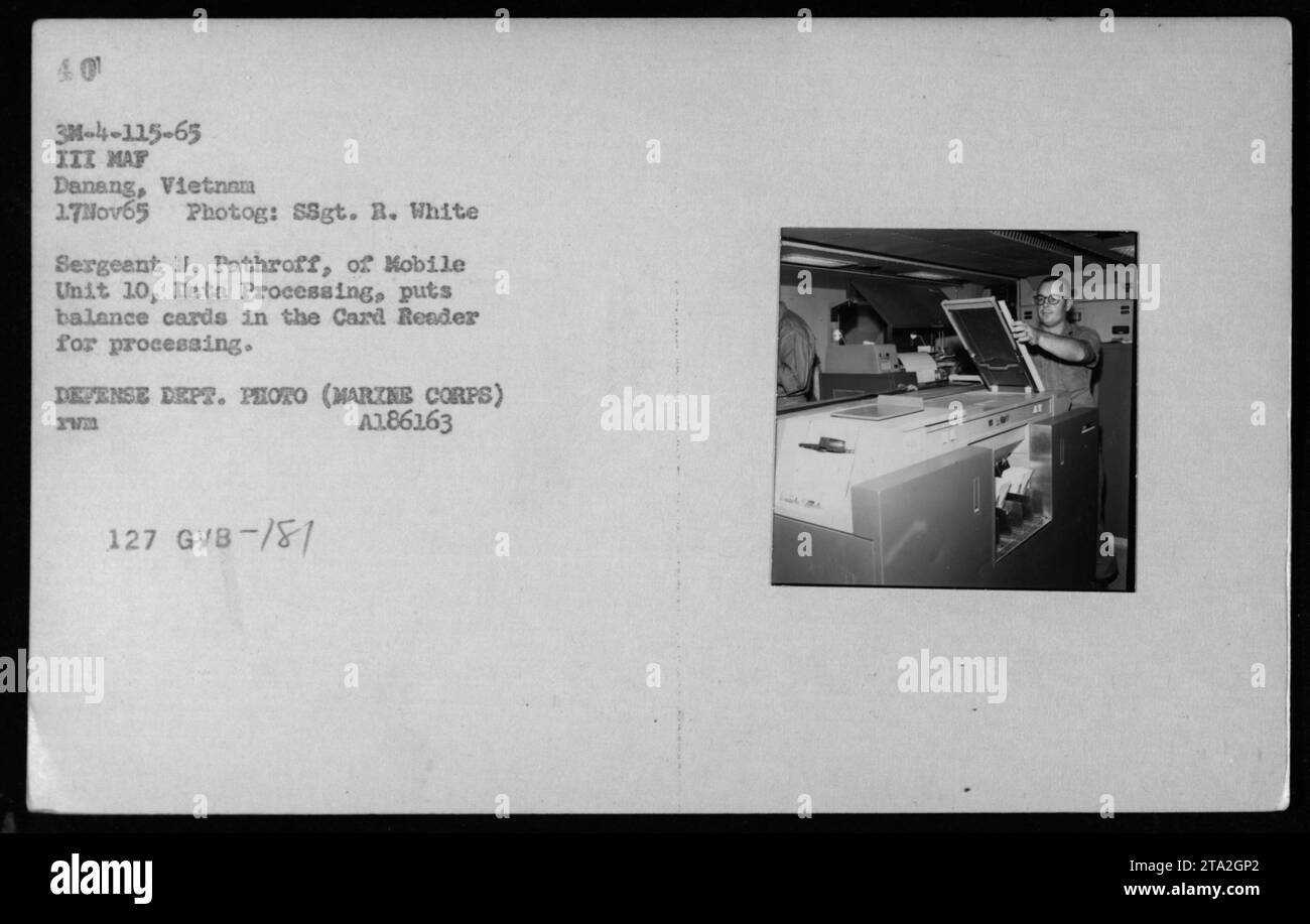 Sergeant M. Pathroff, of Mobile Unit 10, Data Processing, inserts ...