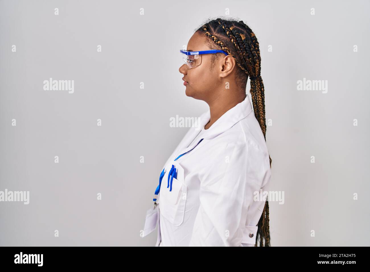 African american woman with braids wearing scientist robe looking to ...