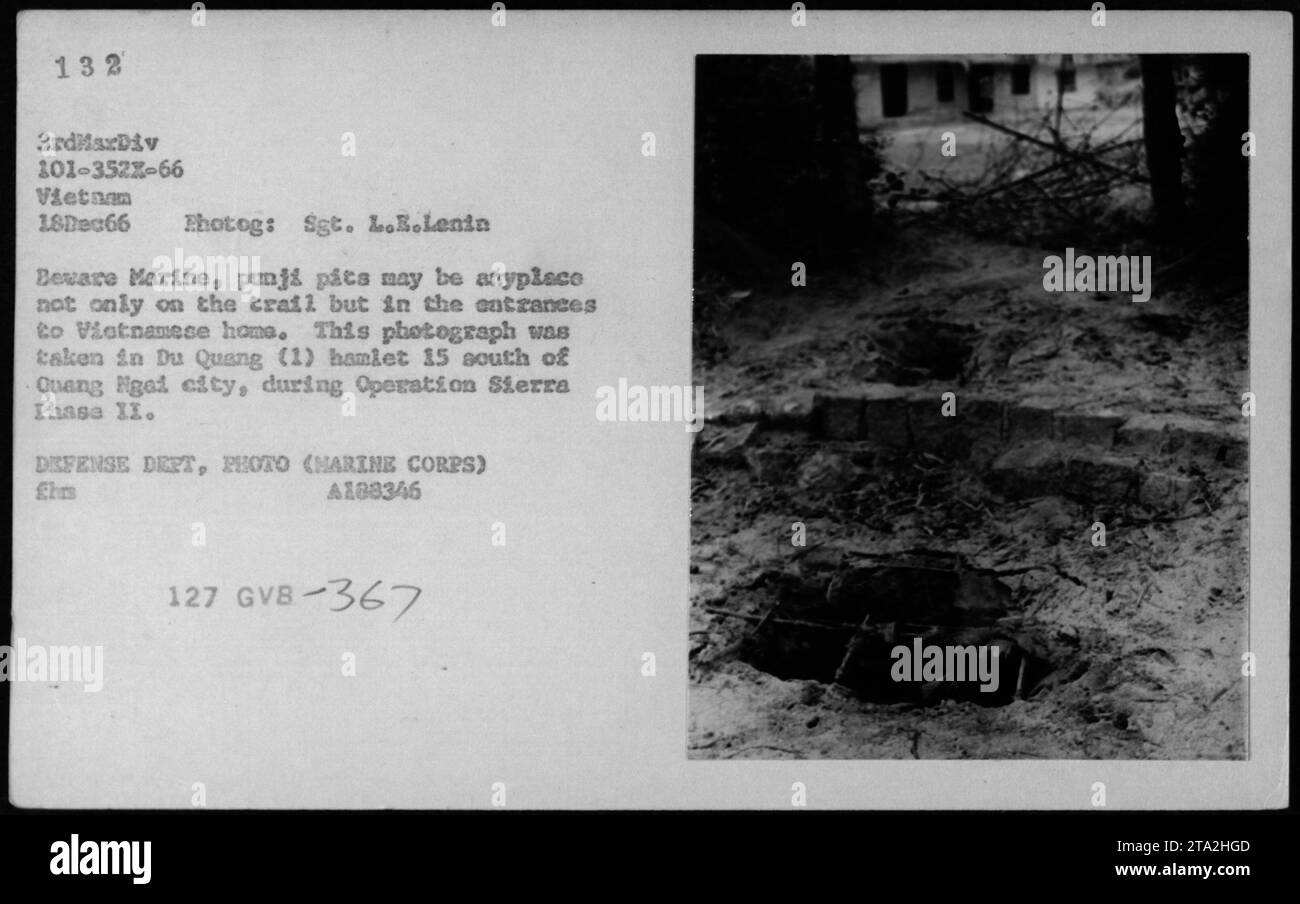A US Marine examines a punji pit in Du Quang hamlet, 15 miles south of ...