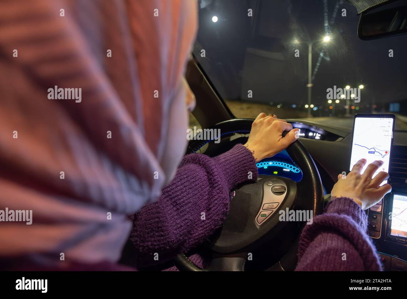 arabic muslim woman driving car at night wearing winter clothes ,hijab ...
