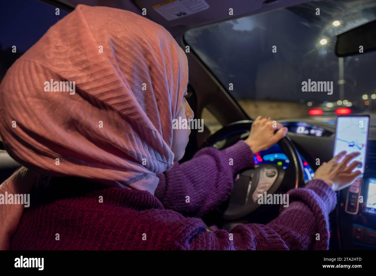 arabic muslim woman driving car at night wearing winter clothes ,hijab ...