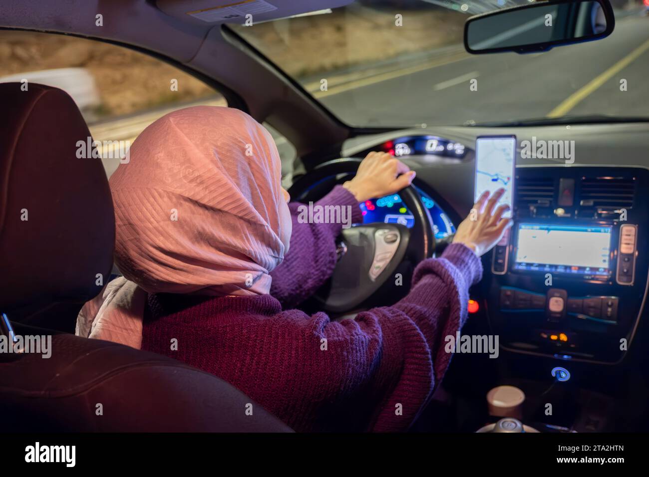 arabic muslim woman driving car at night wearing winter clothes ,hijab ...