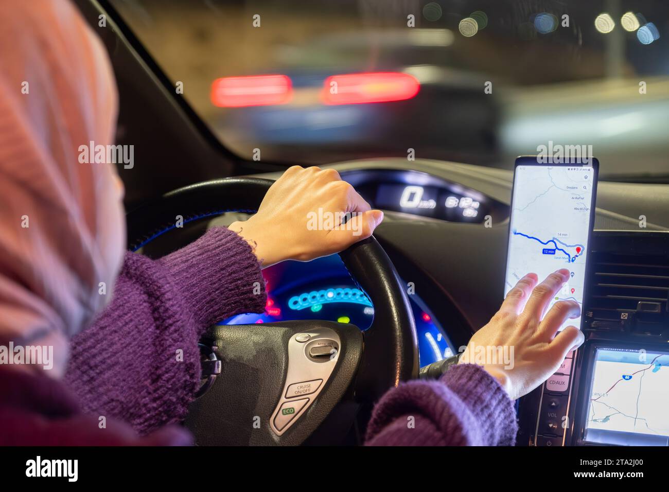 arabic muslim woman driving car at night wearing winter clothes ,hijab ...