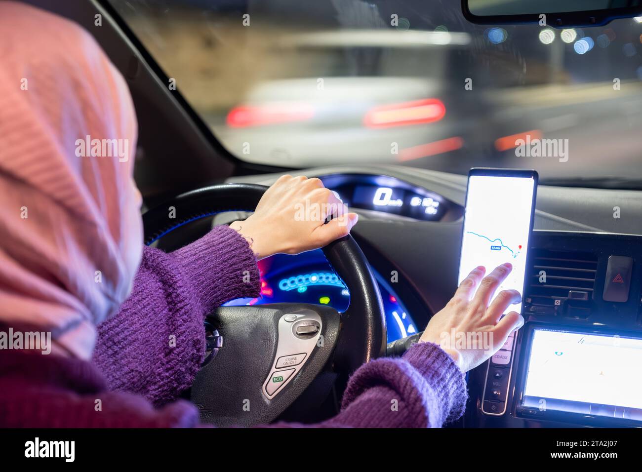 arabic muslim woman driving car at night wearing winter clothes ,hijab ...