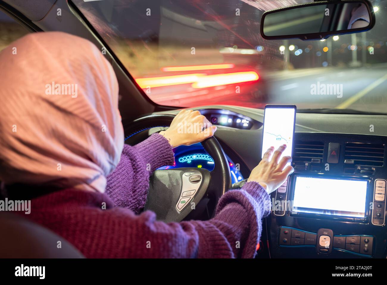 arabic muslim woman driving car at night wearing winter clothes ,hijab ...