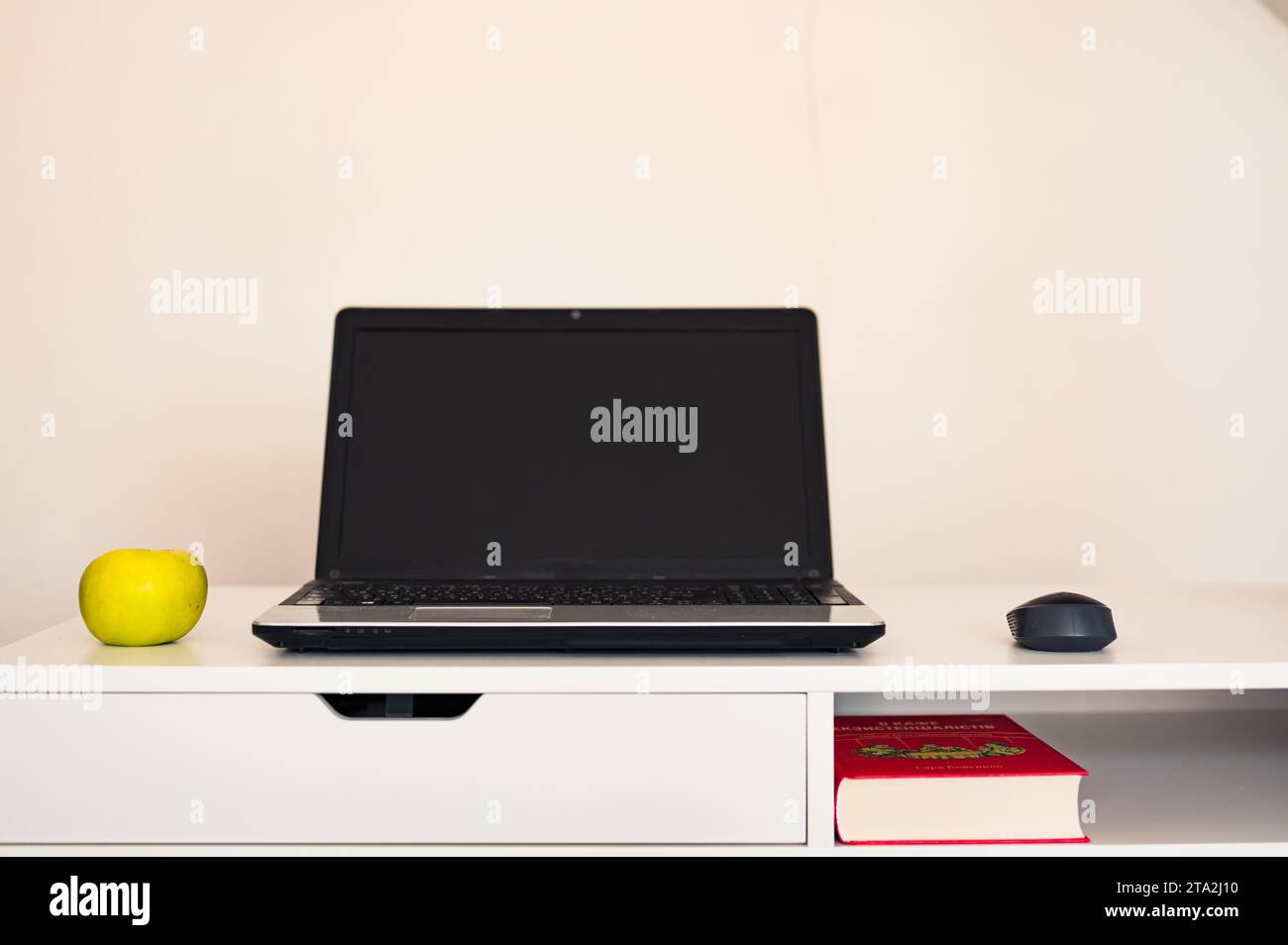 Empty open laptop with mockup and black screen on white desk table ...