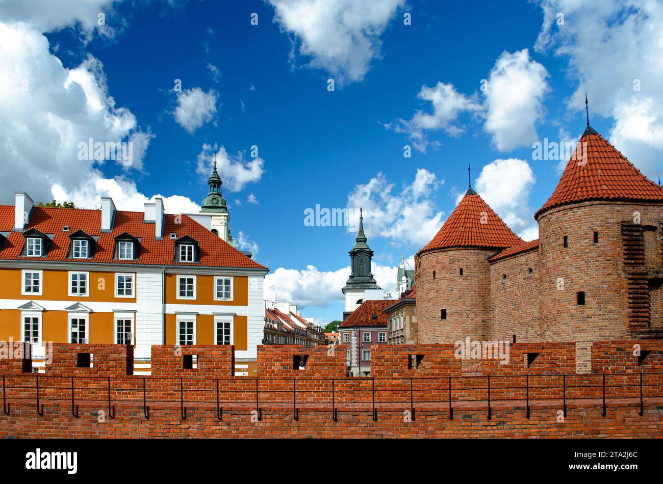Red brick towers (bastions) and city walls of the Warsaw Barbican ...
