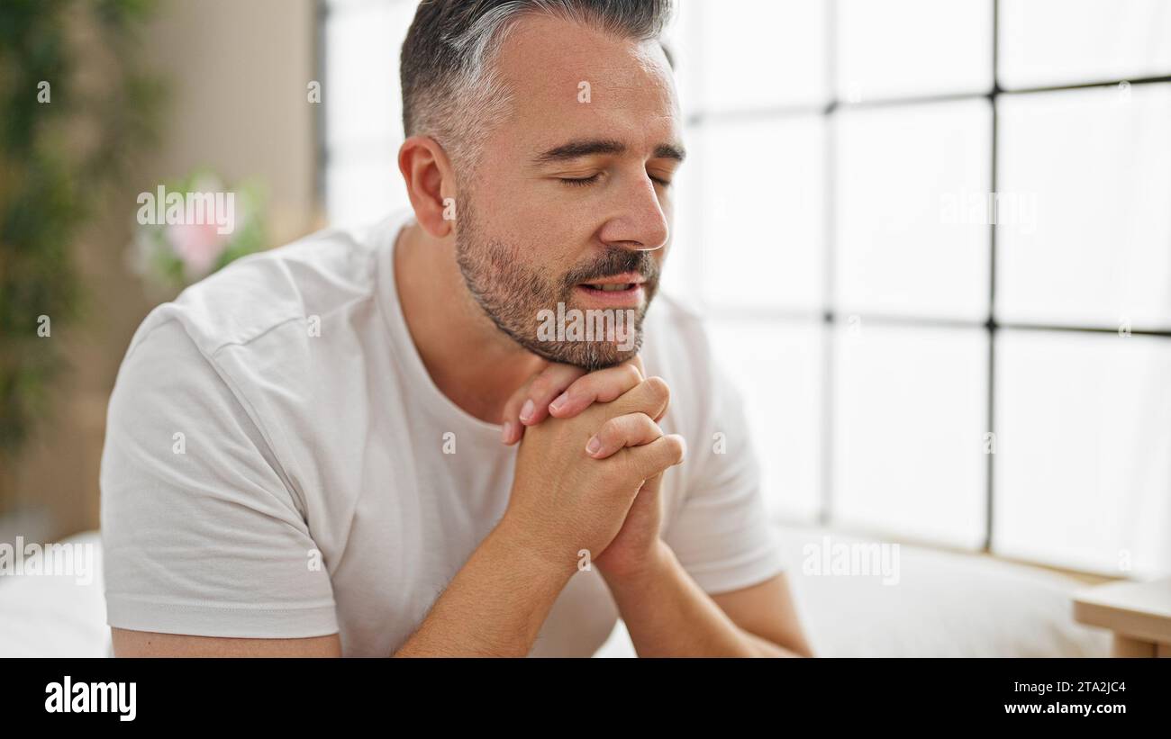Christian man sitting on bed hi-res stock photography and images - Alamy