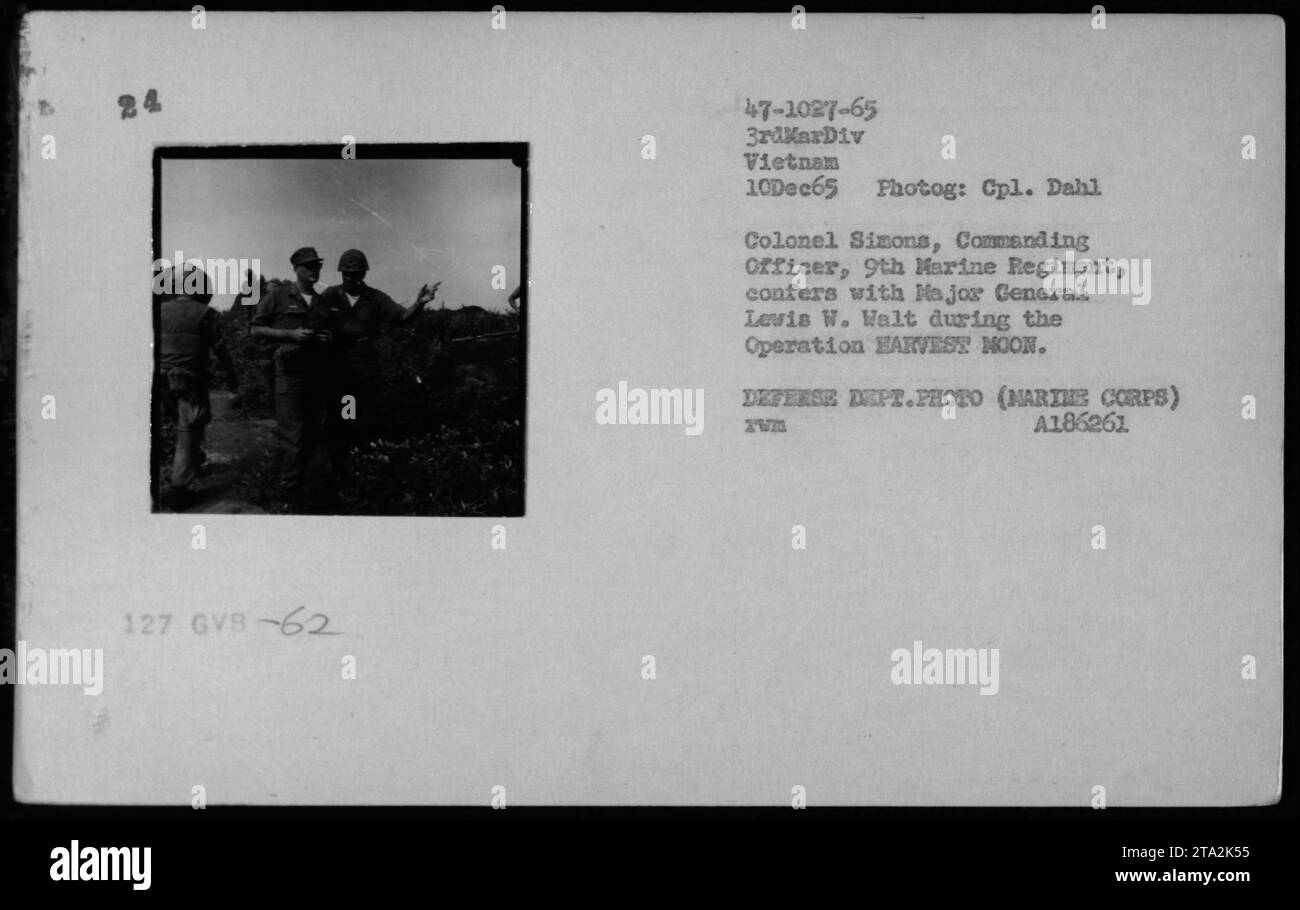 Colonel Simons, Commanding Officer of the 9th Marine Regiment, confers ...