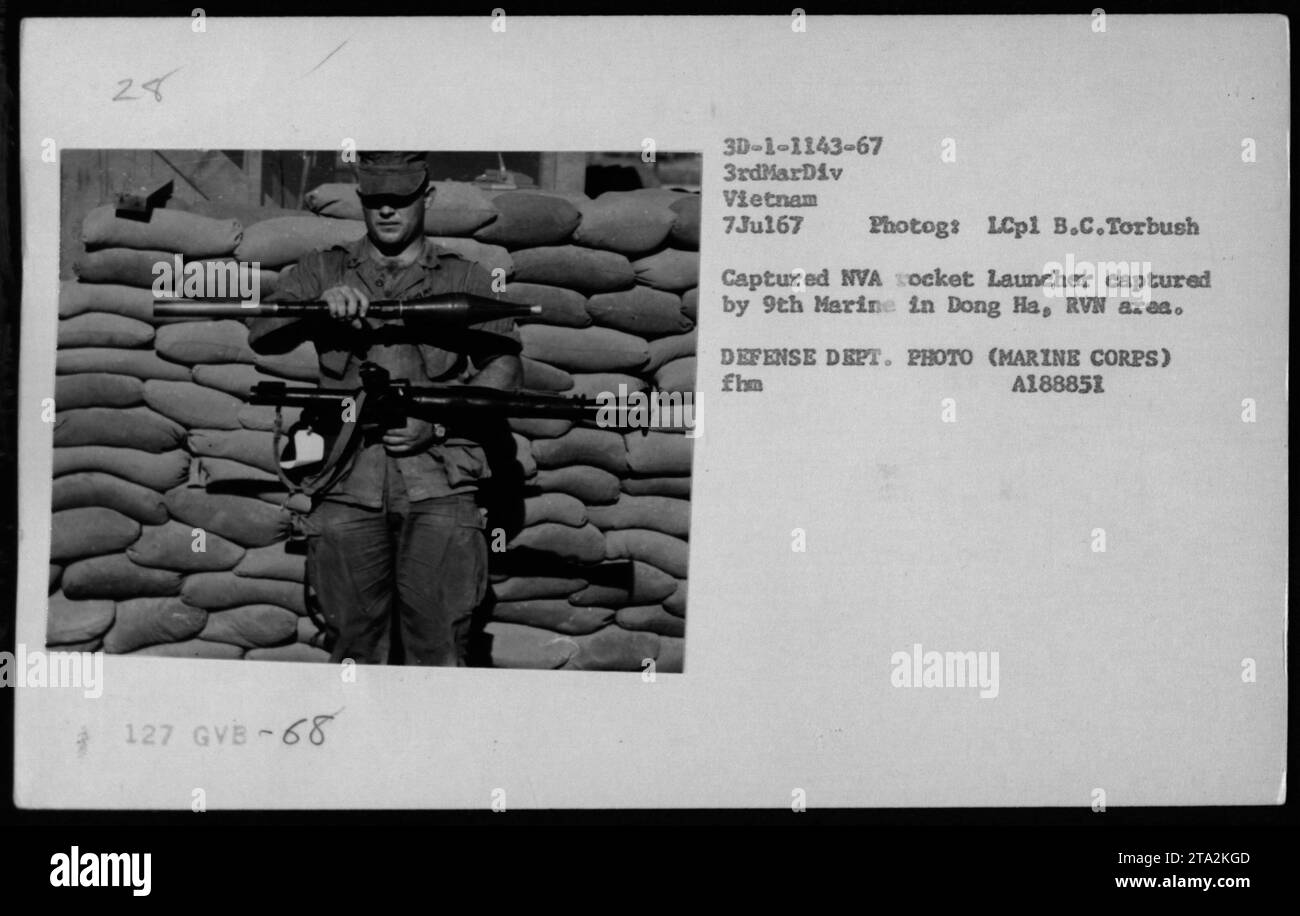 On July 7, 1967, a Marine in Dong Ha, RVN, displayed a captured NVA ...