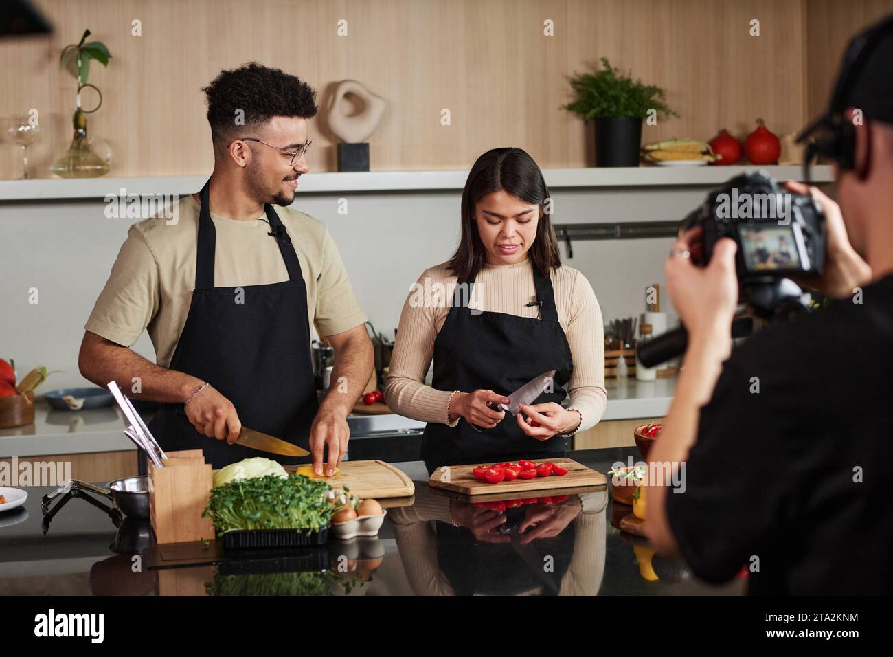 Medium shot of young middle eastern man and hispanic woman cutting ...