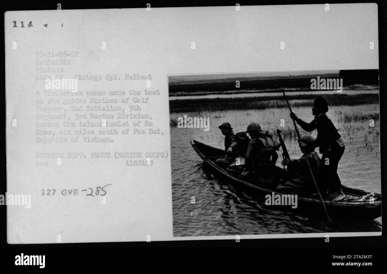 A Vietnamese woman navigates a boat guiding Marines of Golf Company ...