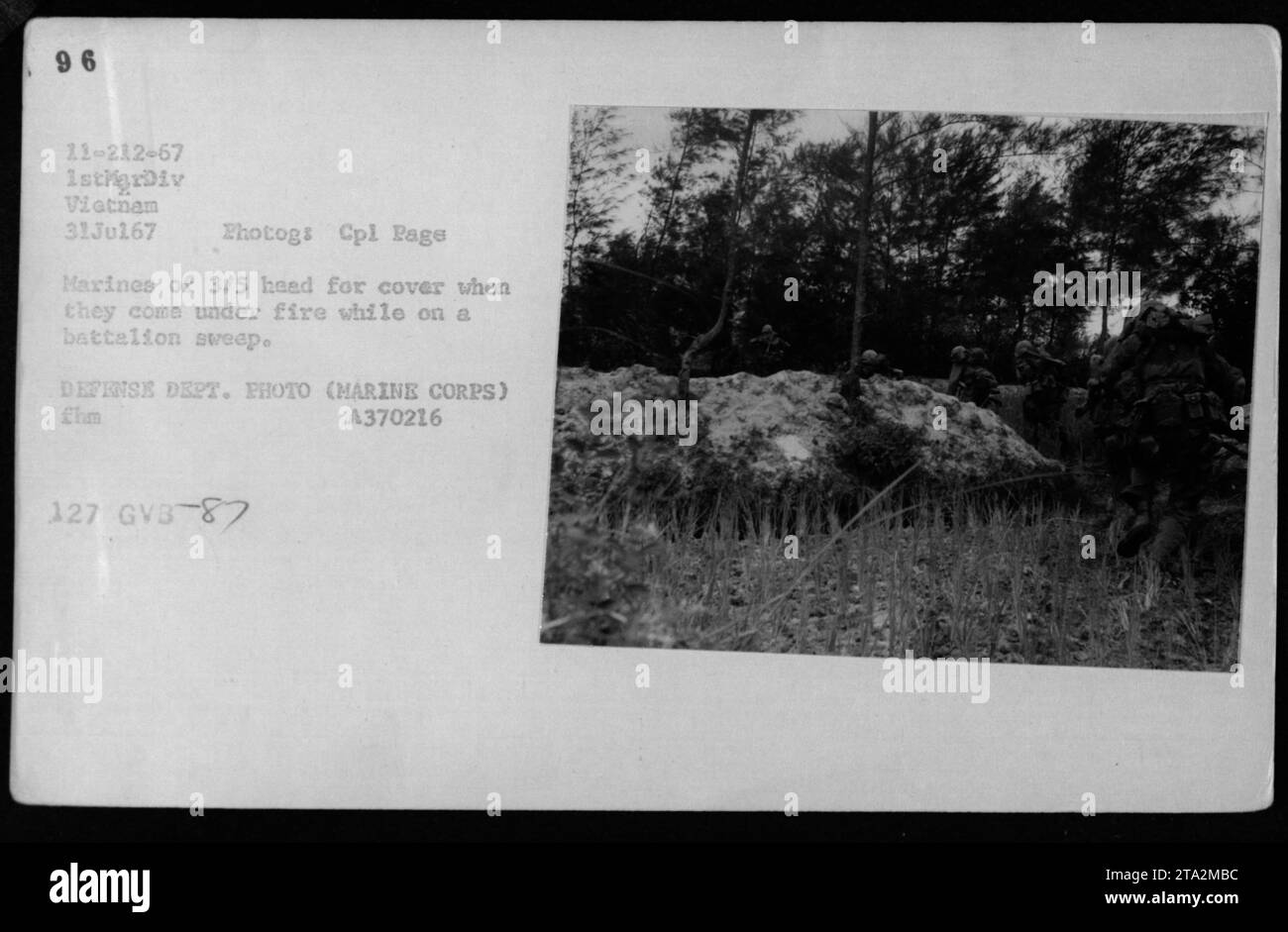 Marines from the 3rd Battalion, 5th Division, seek cover in response to ...