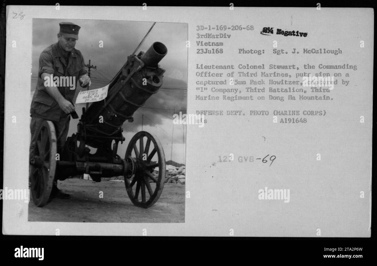 Lieutenant Colonel Stewart of Third Marines places a sign on a 75mm ...