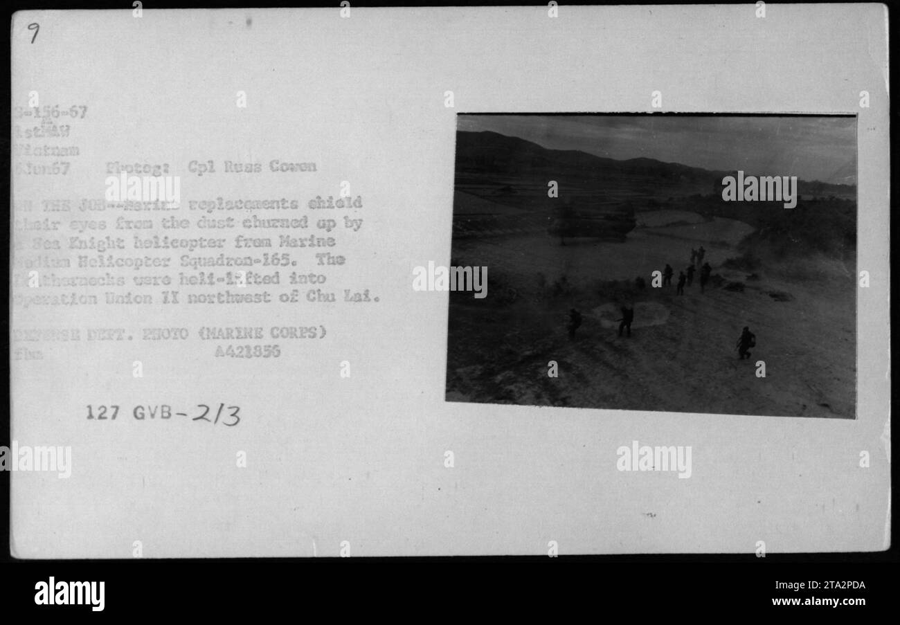 Marine replacements shield their eyes from dust stirred by a Sea Knight ...