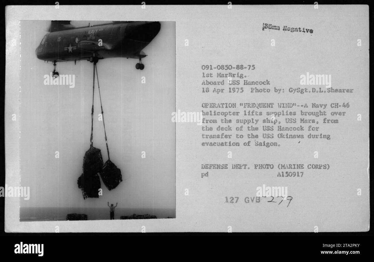 A Navy CH-46 helicopter transfers supplies from USS Hancock to USS ...