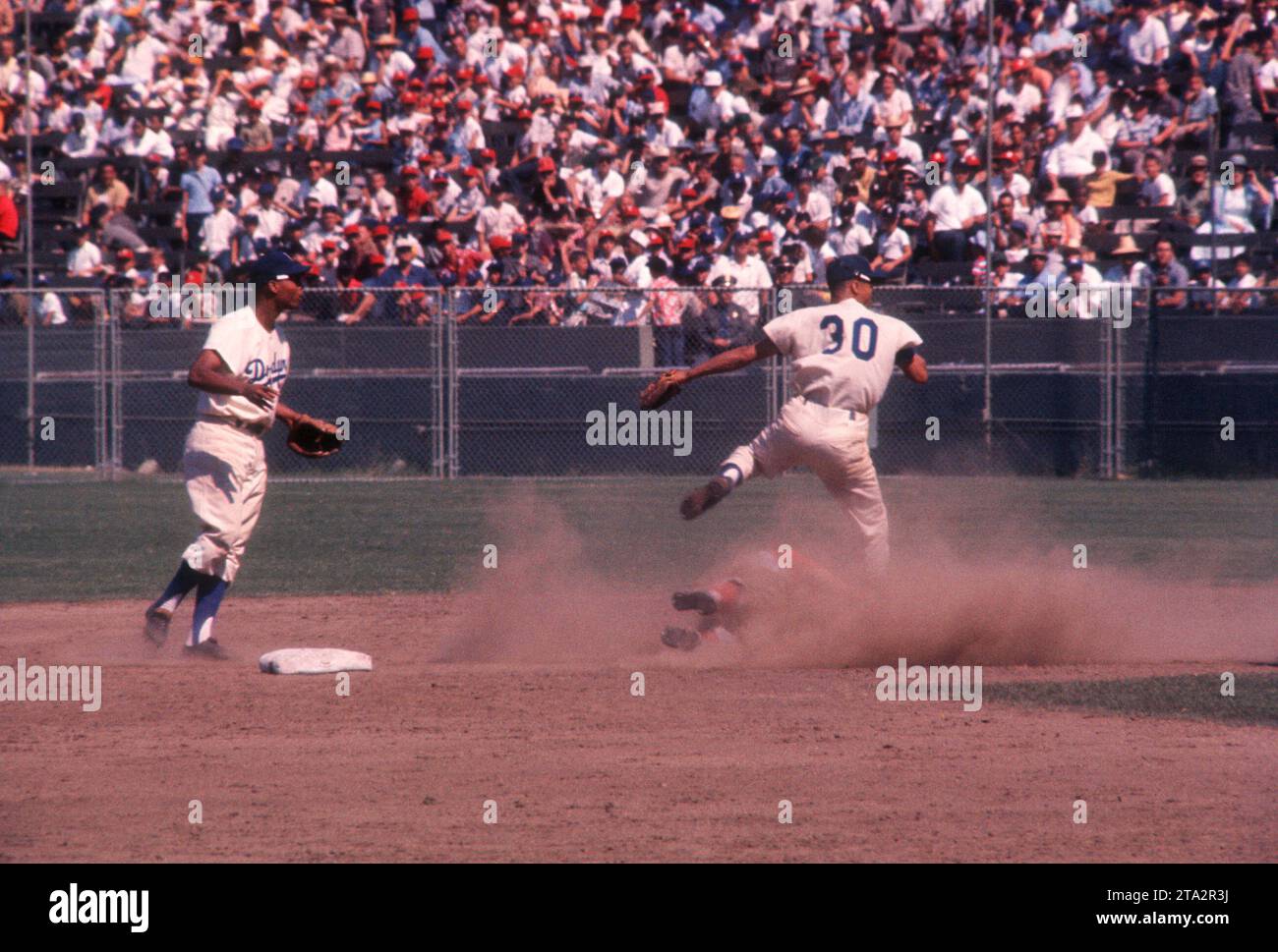 LOS ANGELES, CA - JULY 9: Maury Wills #30 throws to first to complete ...