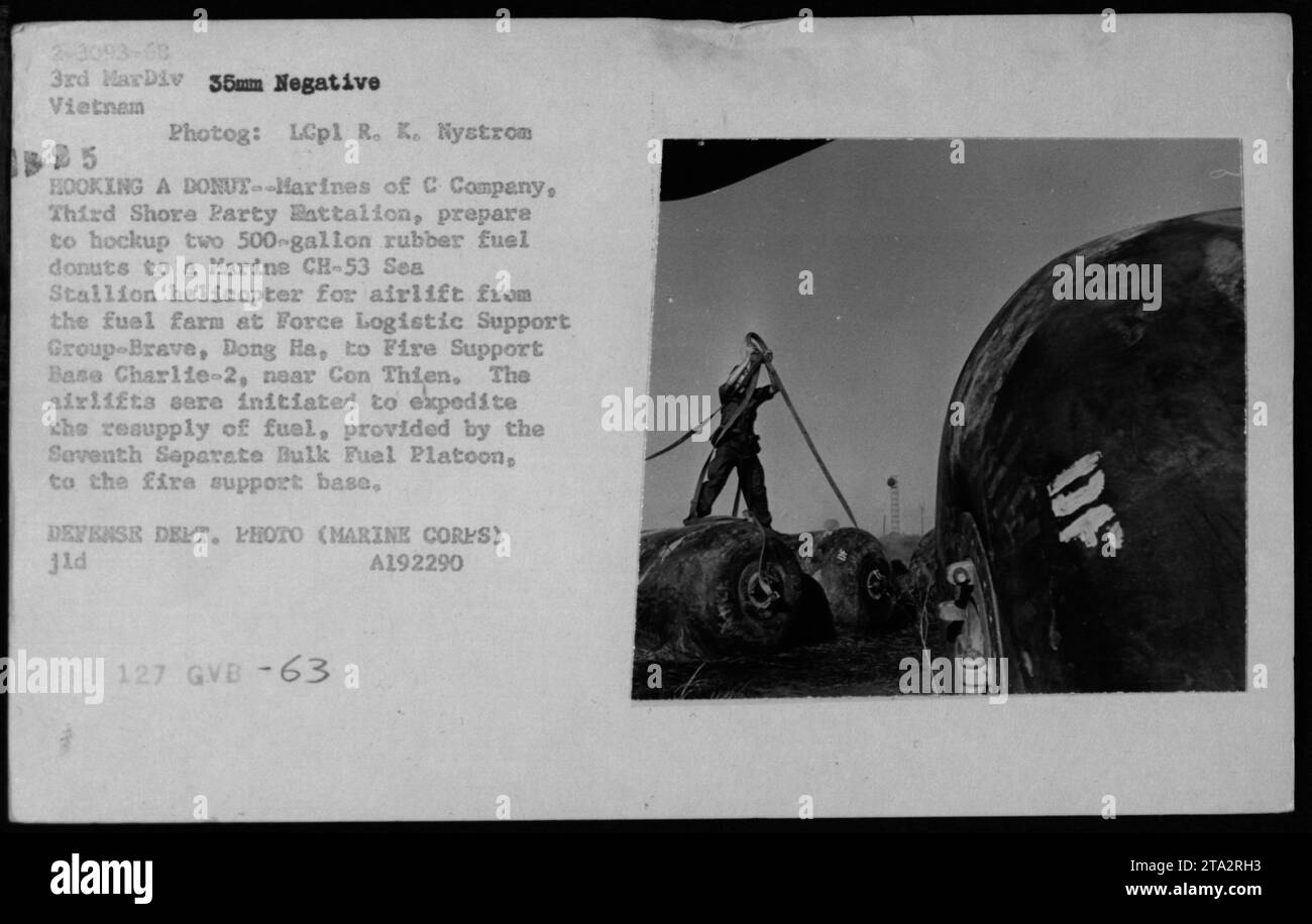 Marines from C Company, Third Shore Party Battalion, are shown hooking ...