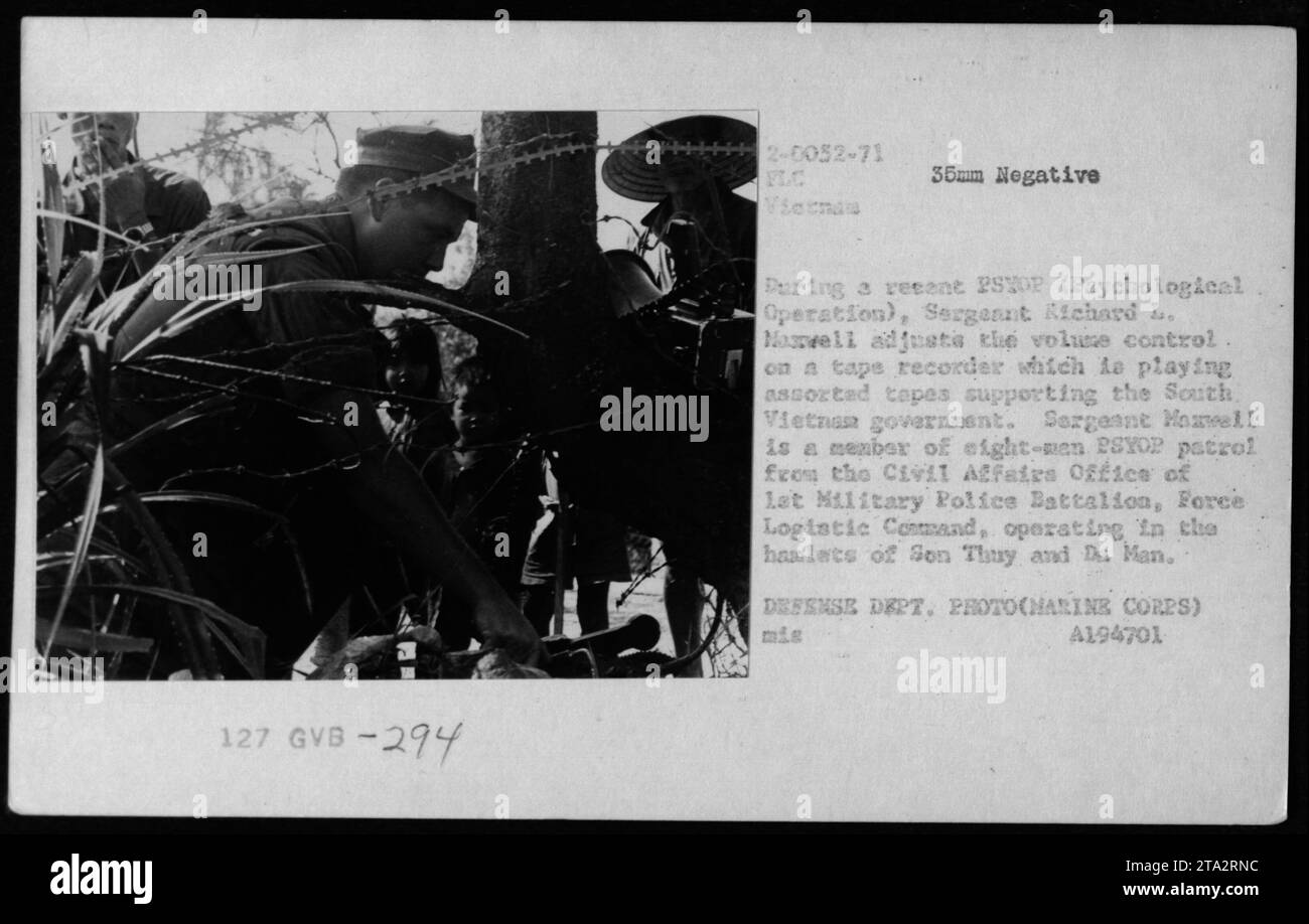 Sergeant Richard L. Maxwell adjusts the volume control on a tape ...