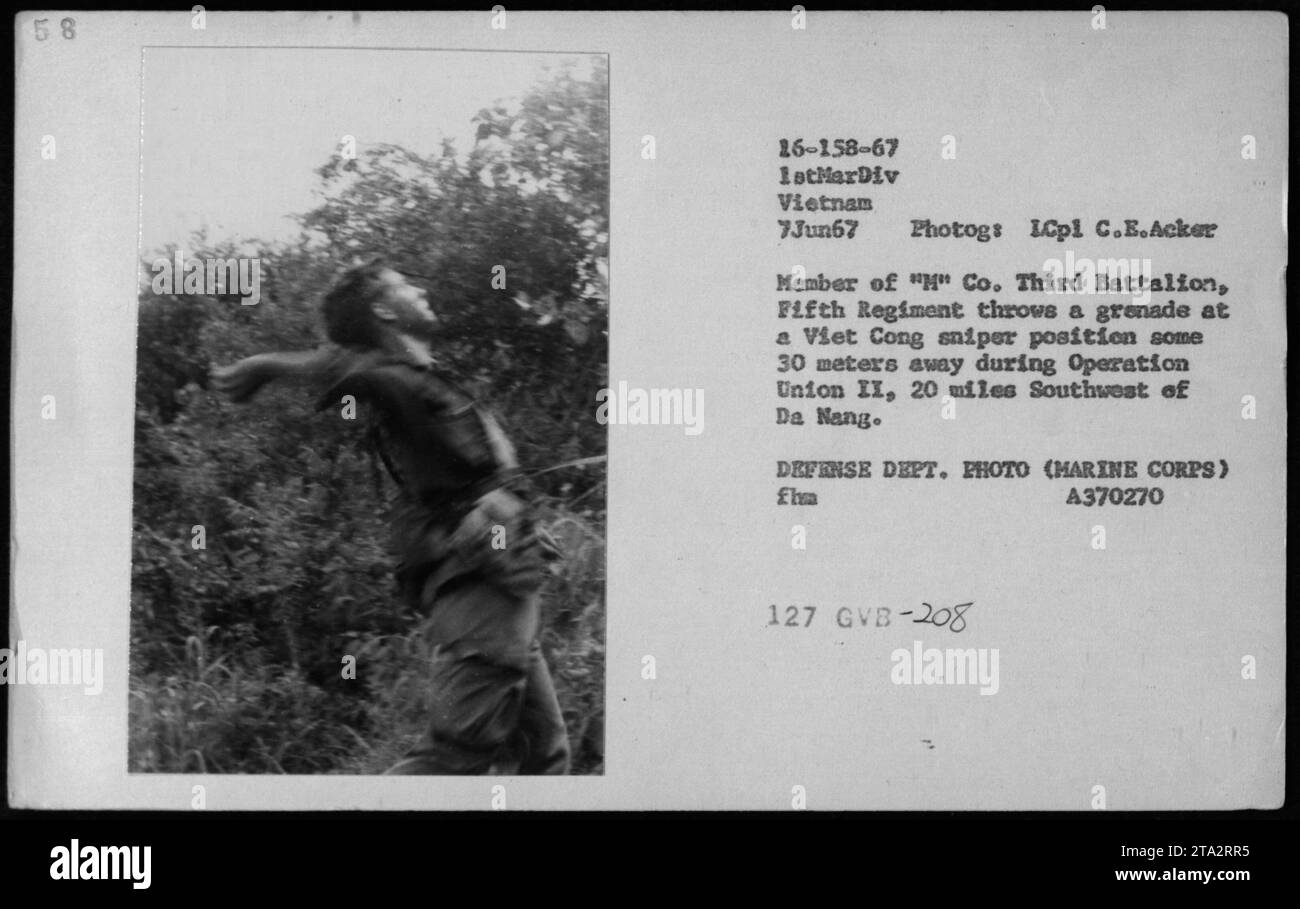 A Marine corporal from M Company, 3rd Battalion, 5th Regiment throws a ...