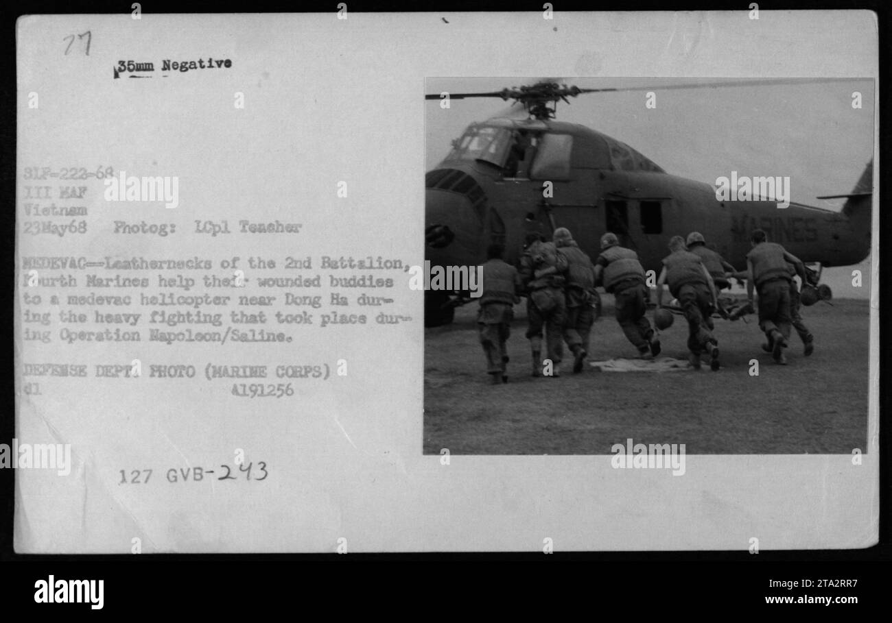 Marine Corps medics assist wounded comrades onto a medevac helicopter ...