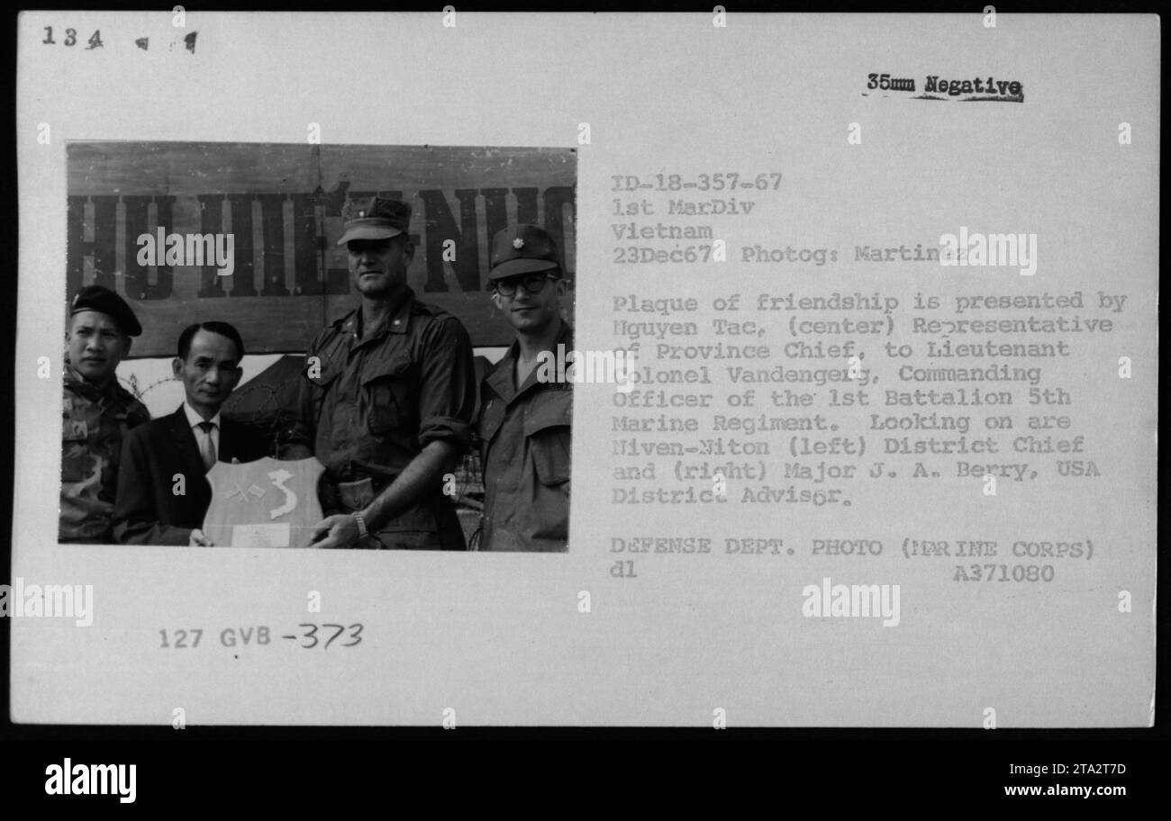 On December 23, 1967, Vietnamese civilian Nguyen Tac presents a plaque ...
